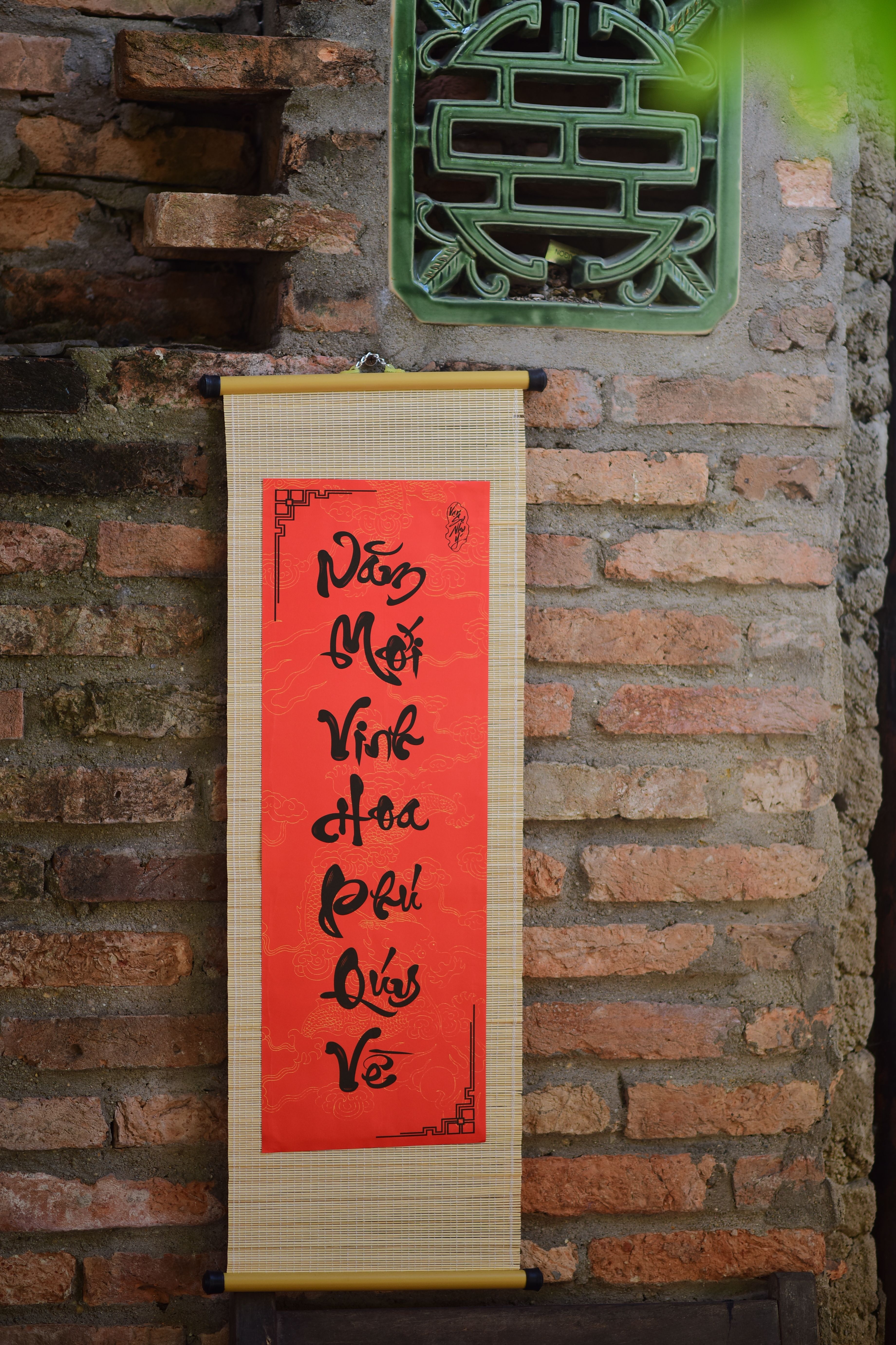 Traditional Vietnamese Calligraphy Scroll on Brick Wall · Free Stock Photo