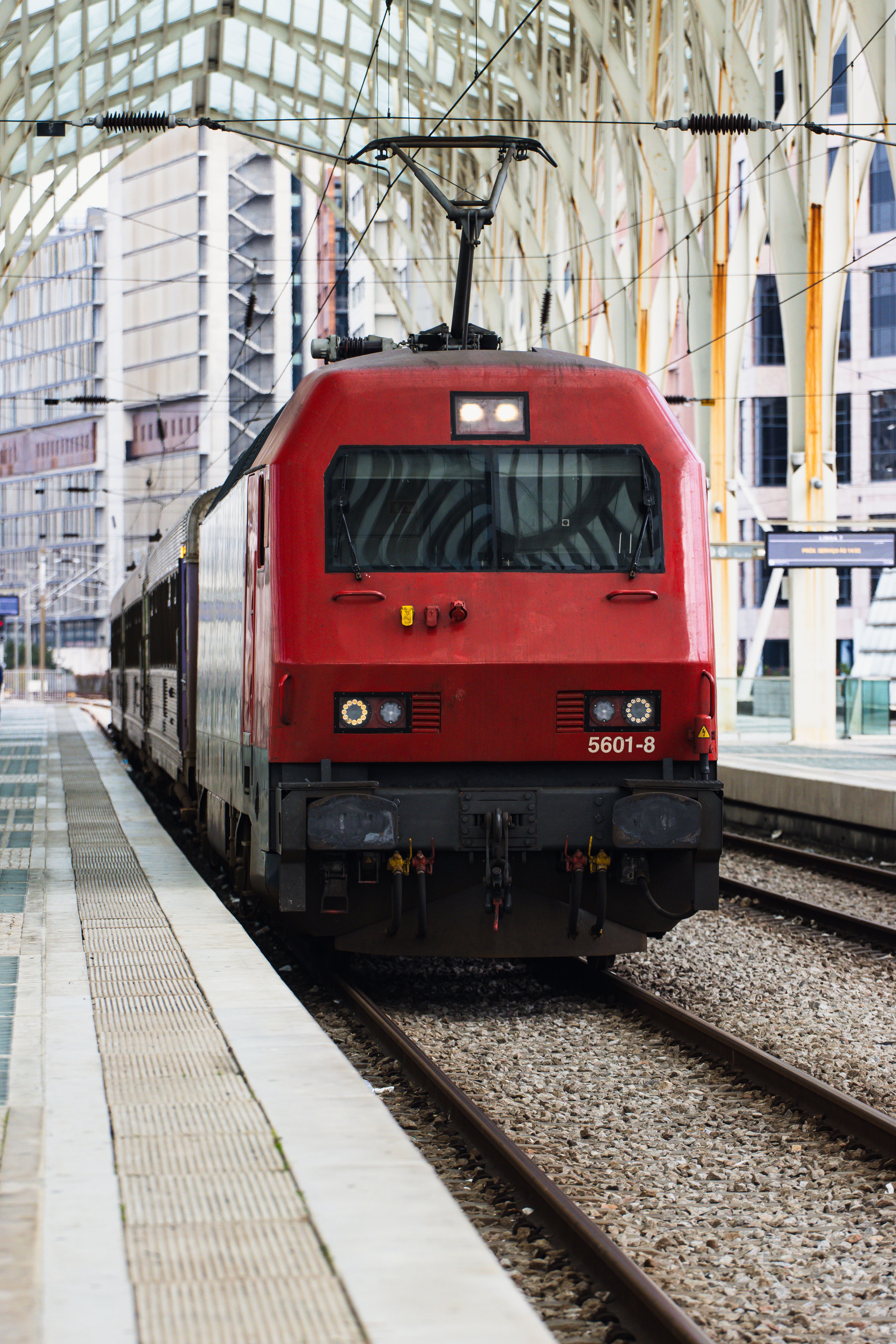 Red Train at a Green Train Station on an Overcast Day · Free Stock Photo
