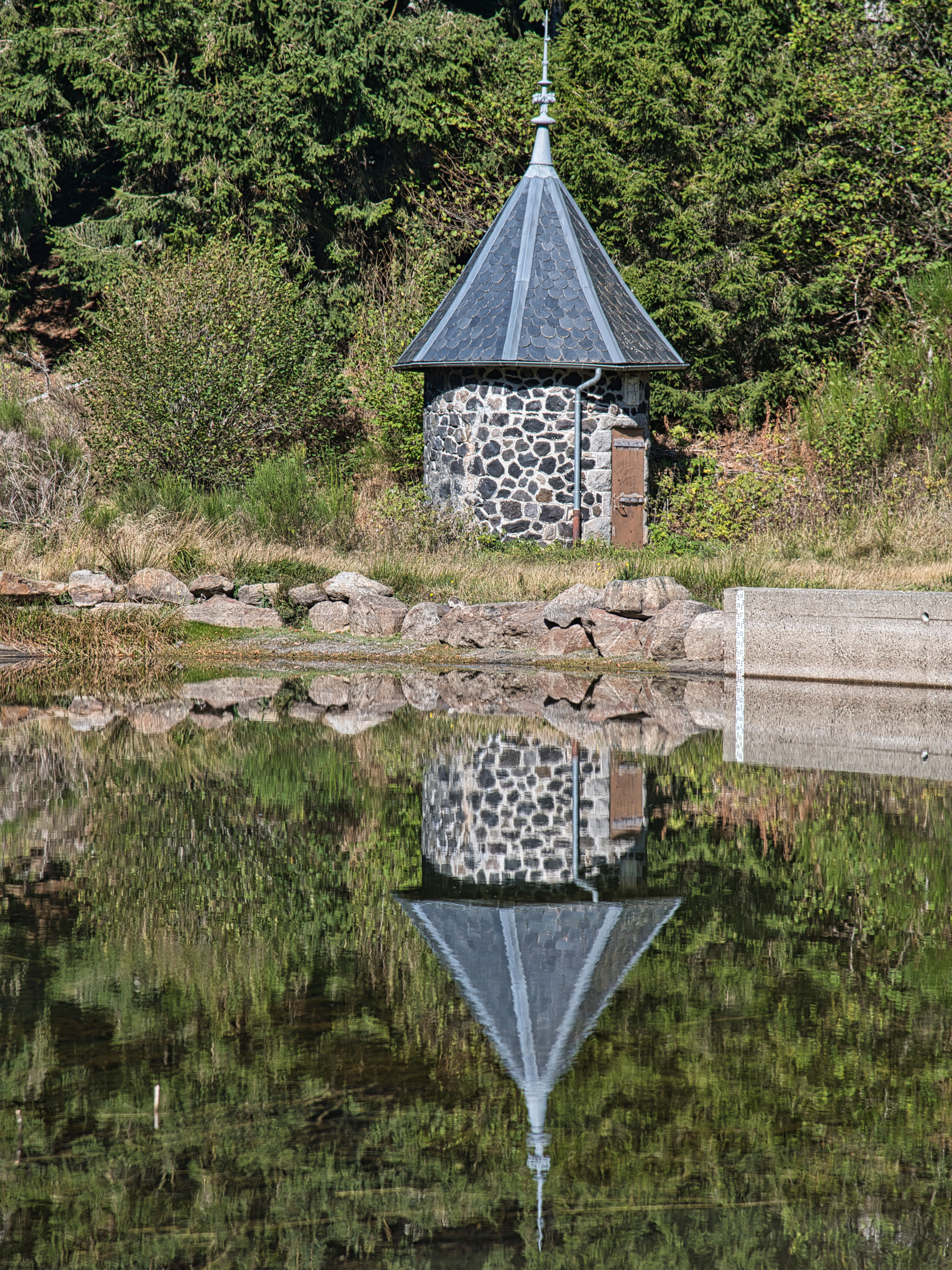 Stone Pavilion by Reflective Lake in Forest Setting · Free Stock Photo