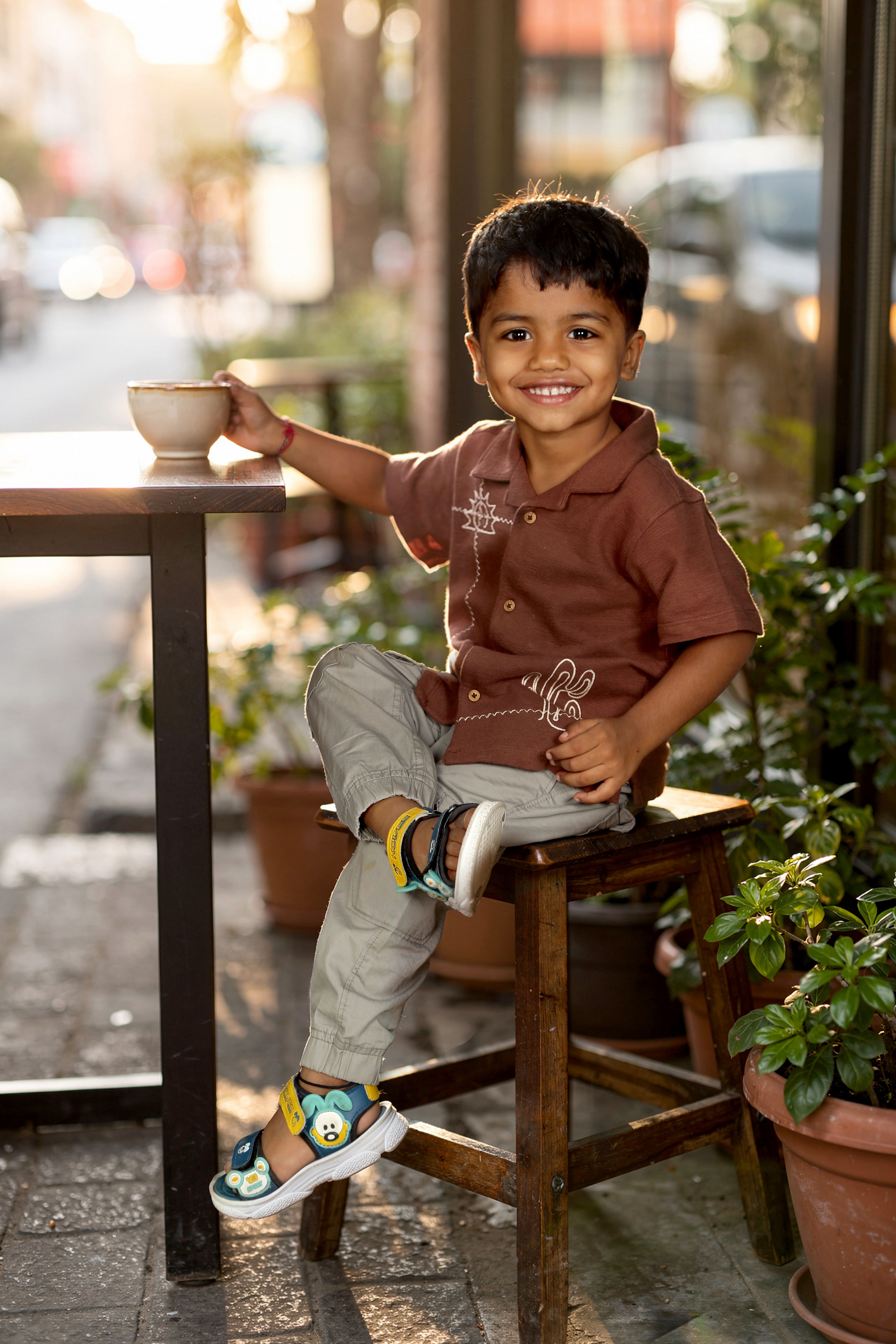 Adorable Child Enjoying Outdoor Coffee Moment · Free Stock Photo