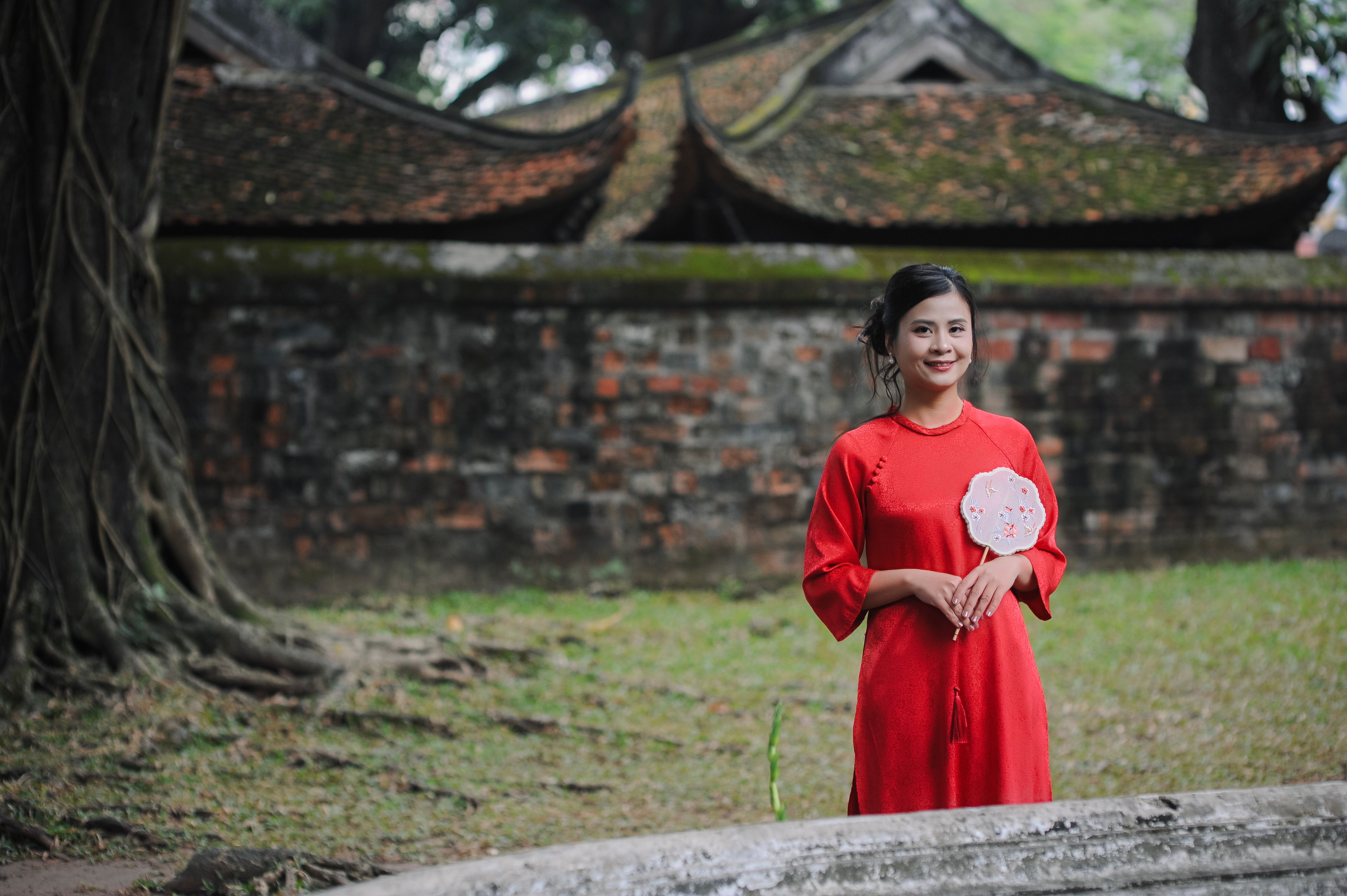 Woman in Traditional Red Dress with Fan Outdoors · Free Stock Photo