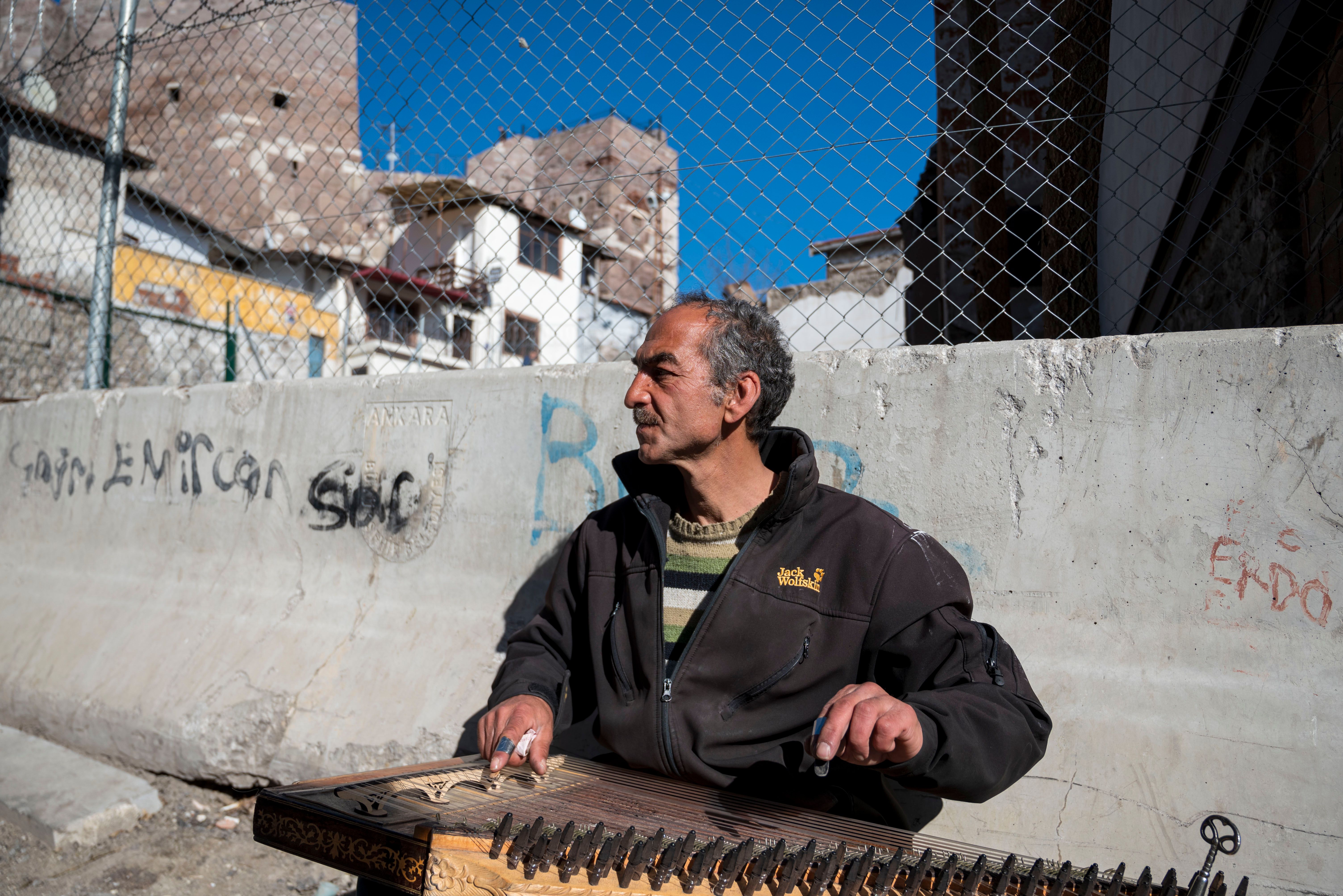 Street musician playing traditional instrument outdoors · Free Stock Photo