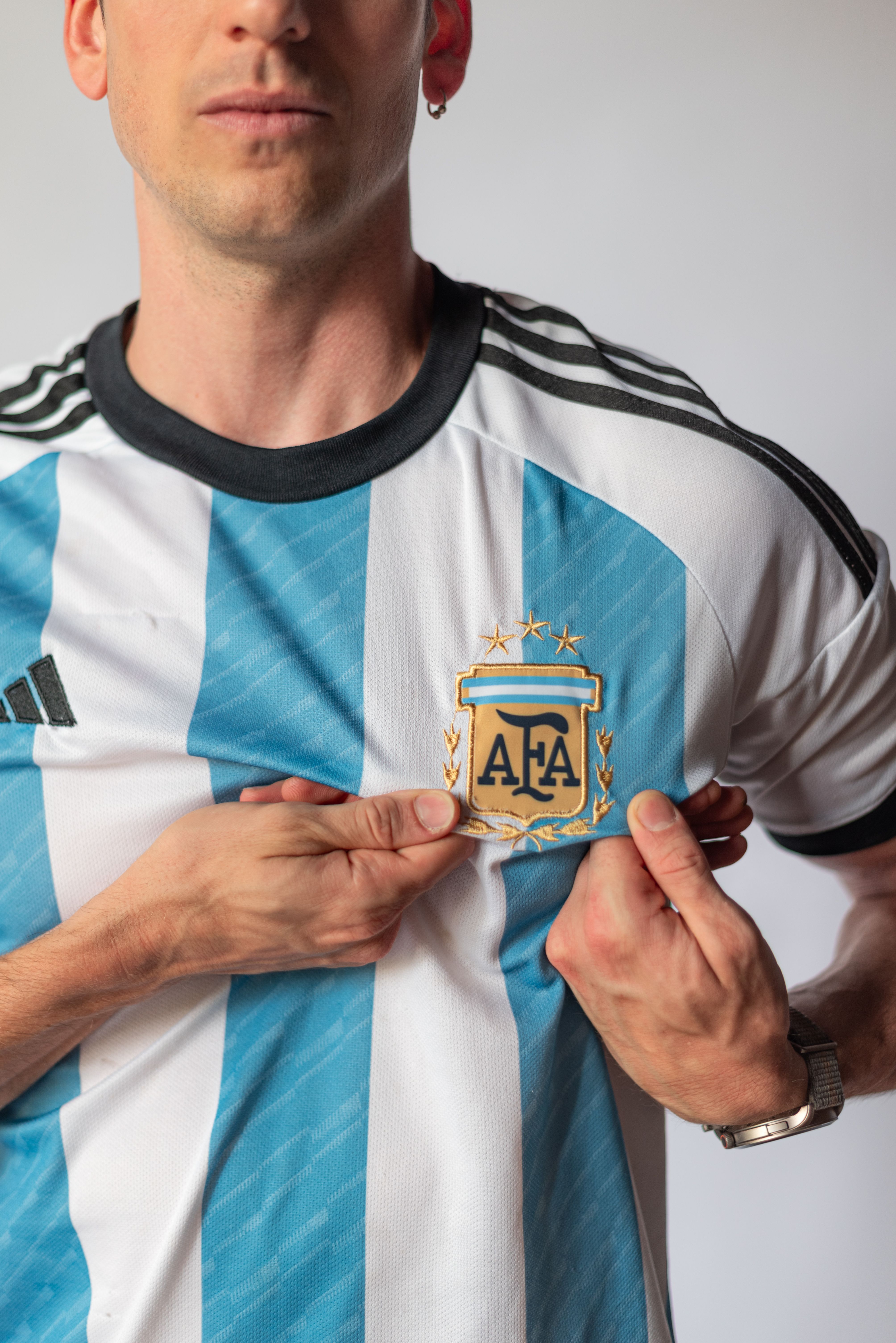 Man Holding Argentinian Football Shirt Emblem · Free Stock Photo
