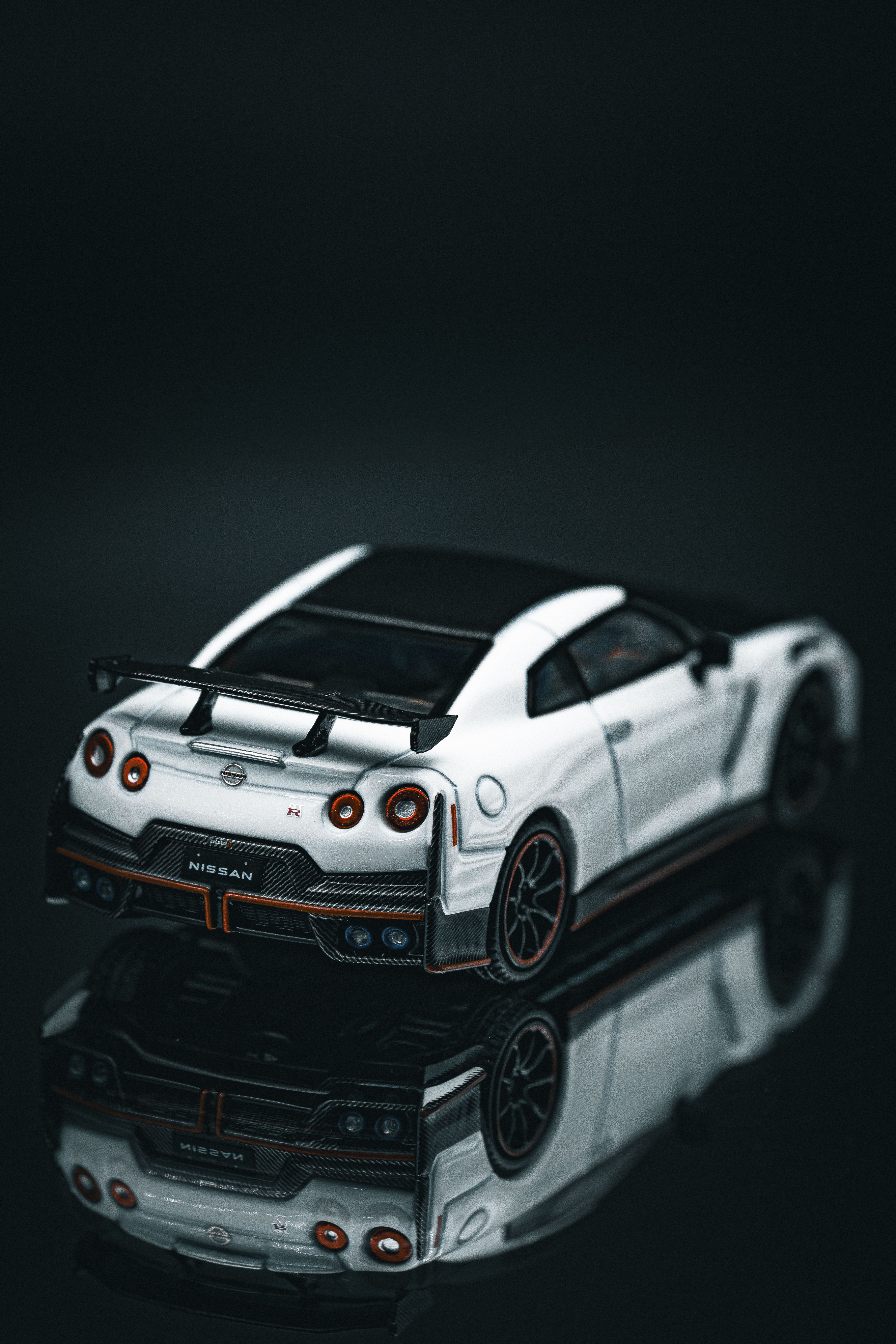 White Sports Car Model on Reflective Surface · Free Stock Photo