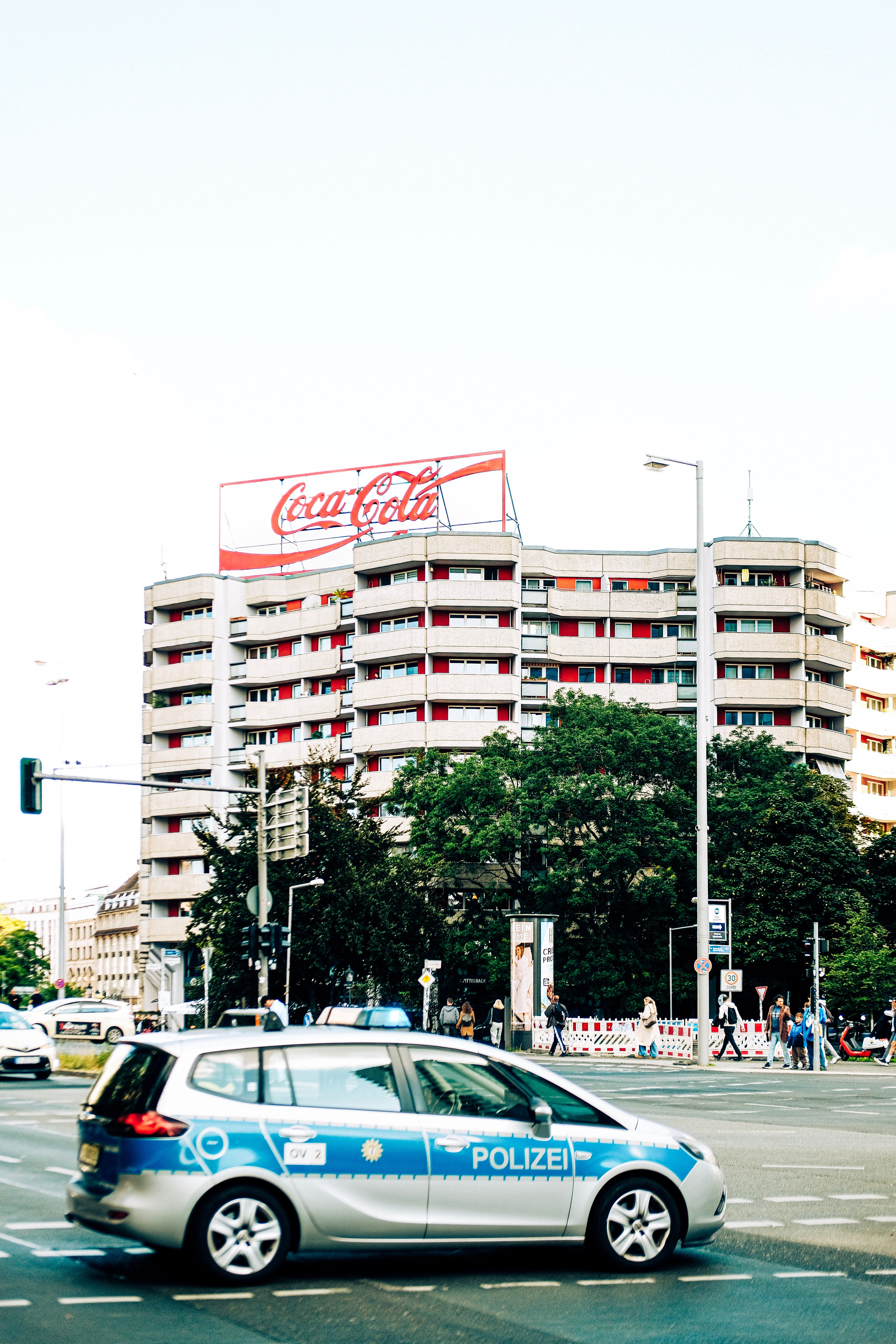 Coca-Cola Building in Berlin with Police Car · Free Stock Photo