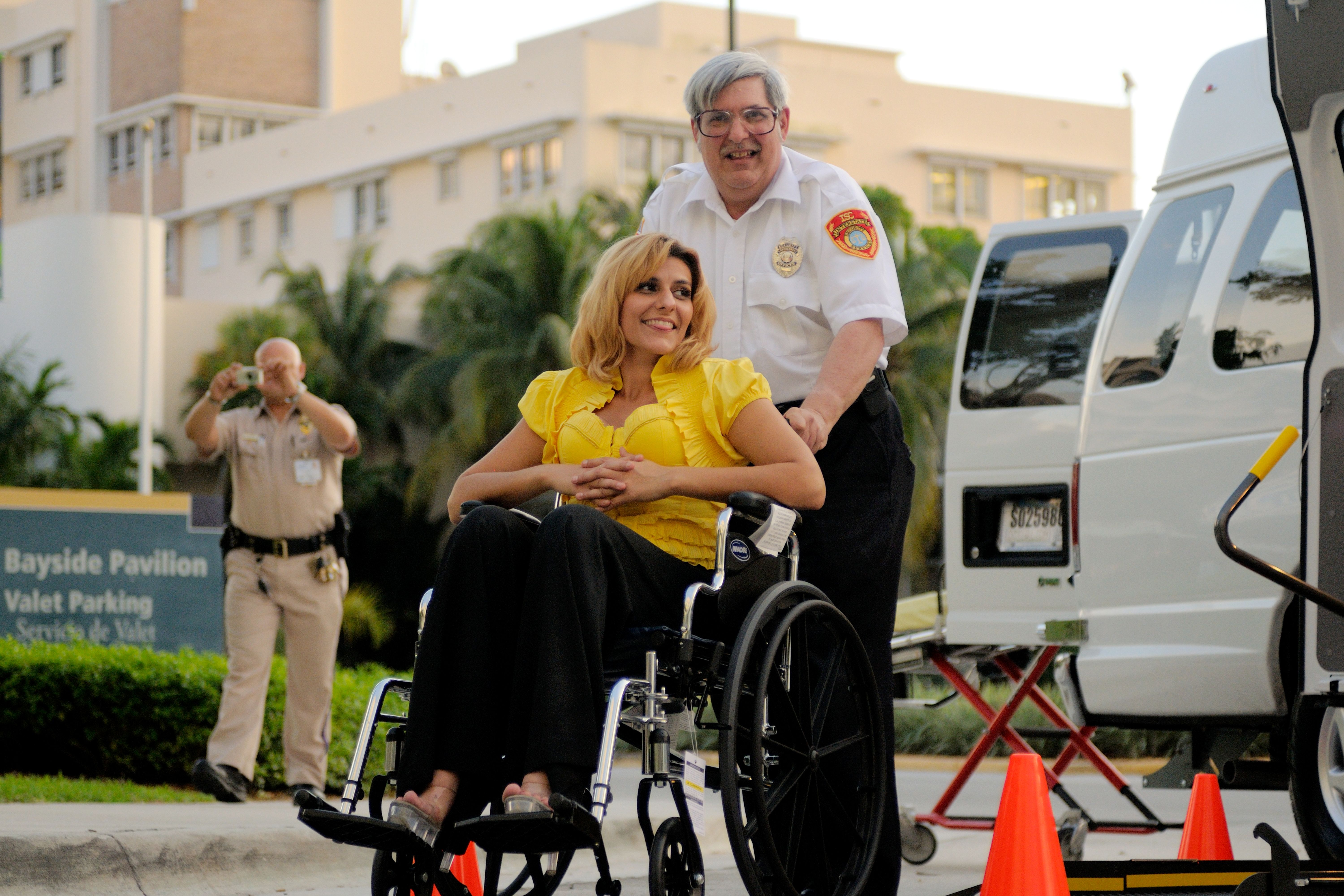 Security Guard Assisting Woman in Wheelchair · Free Stock Photo
