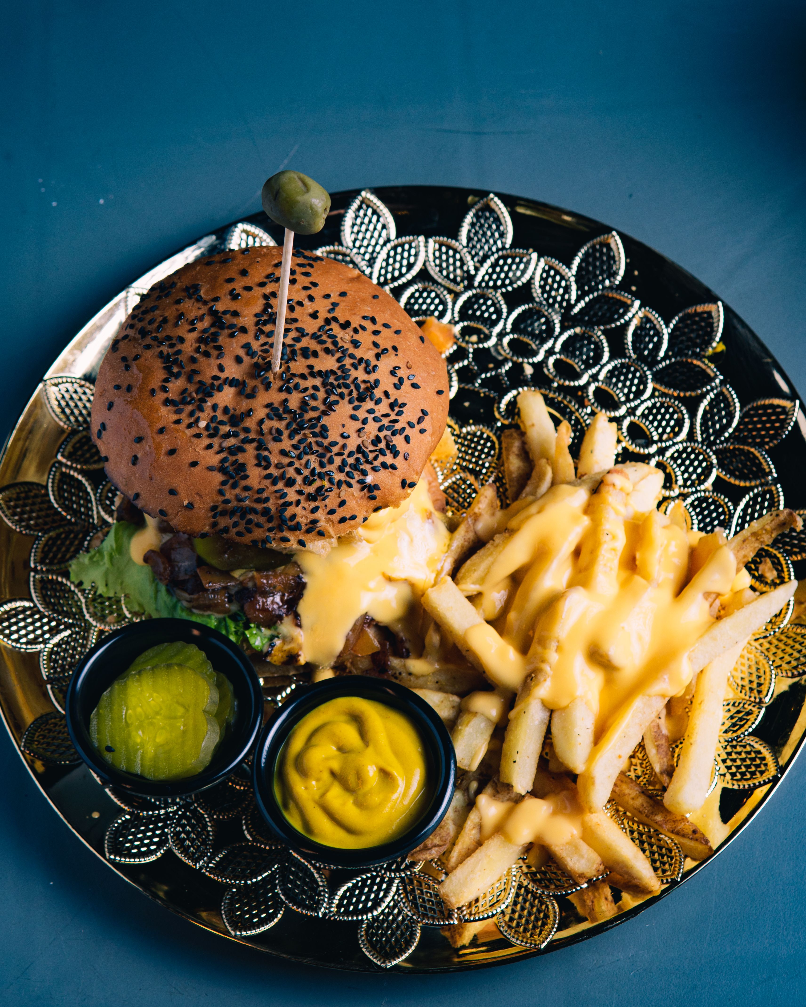 Gourmet Cheeseburger with Fries on Decorative Plate · Free Stock Photo