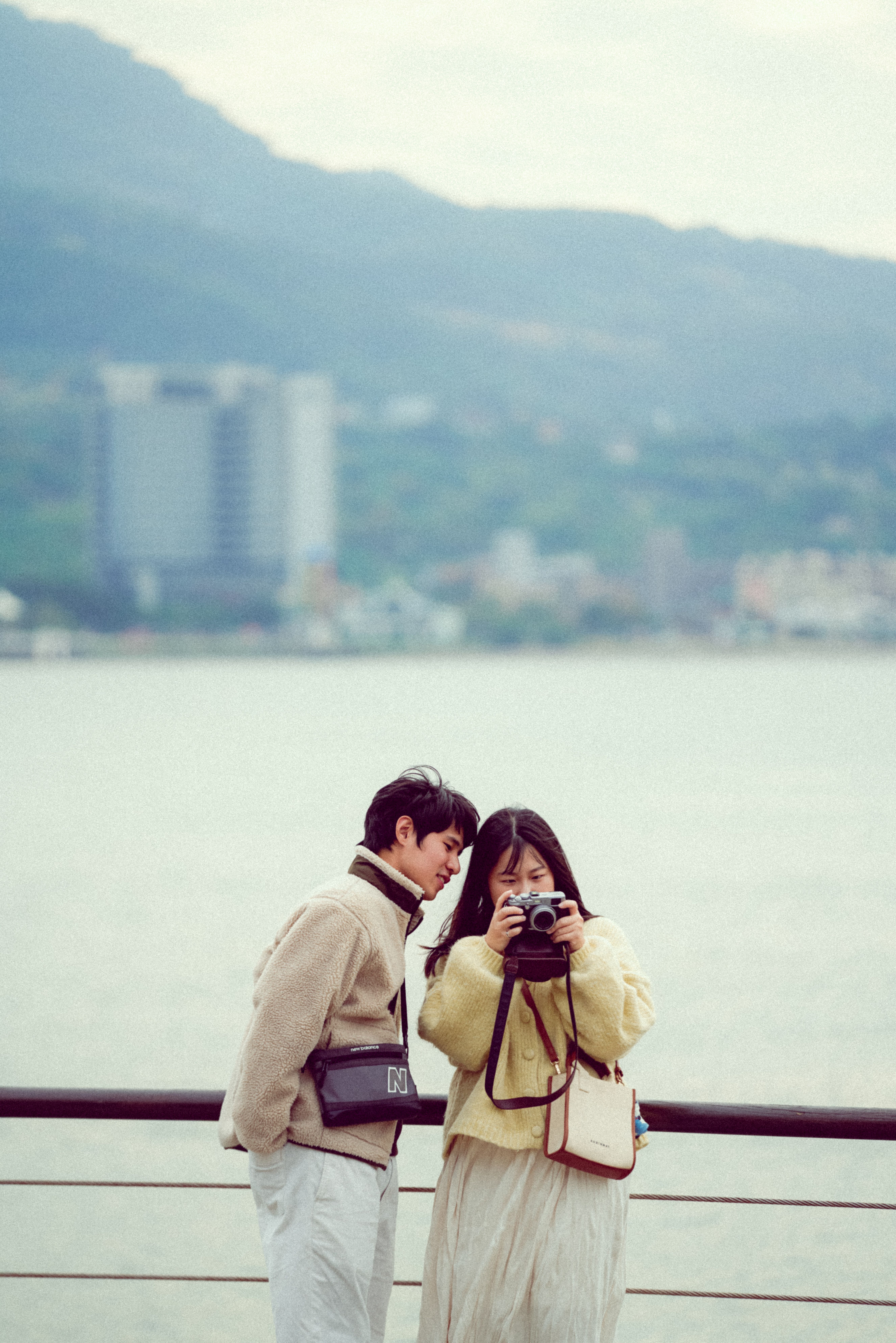 Young couple taking photos by scenic waterfront in Taiwan · Free Stock ...
