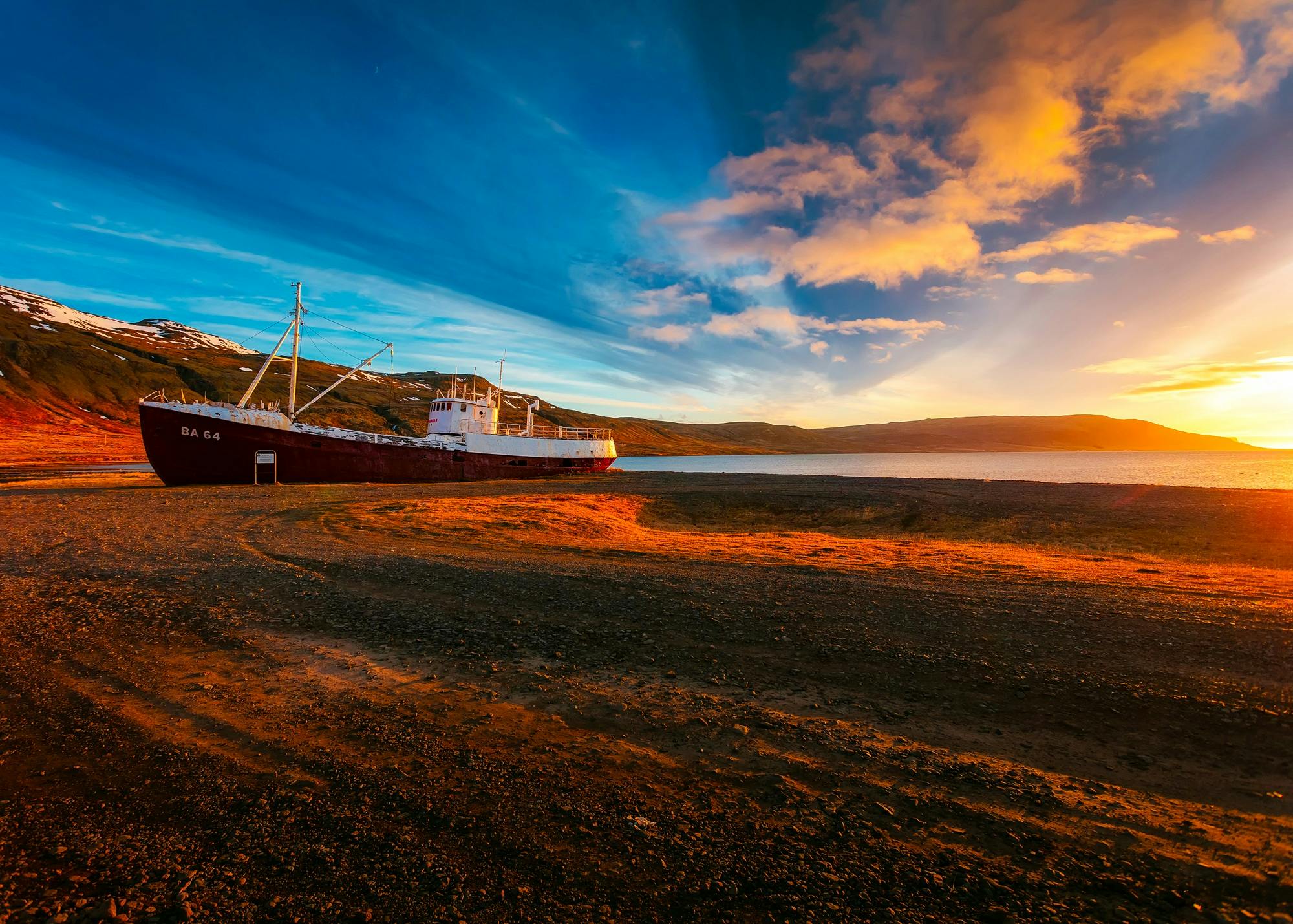 White and Maroon Cargo Ship on Sand · Free Stock Photo