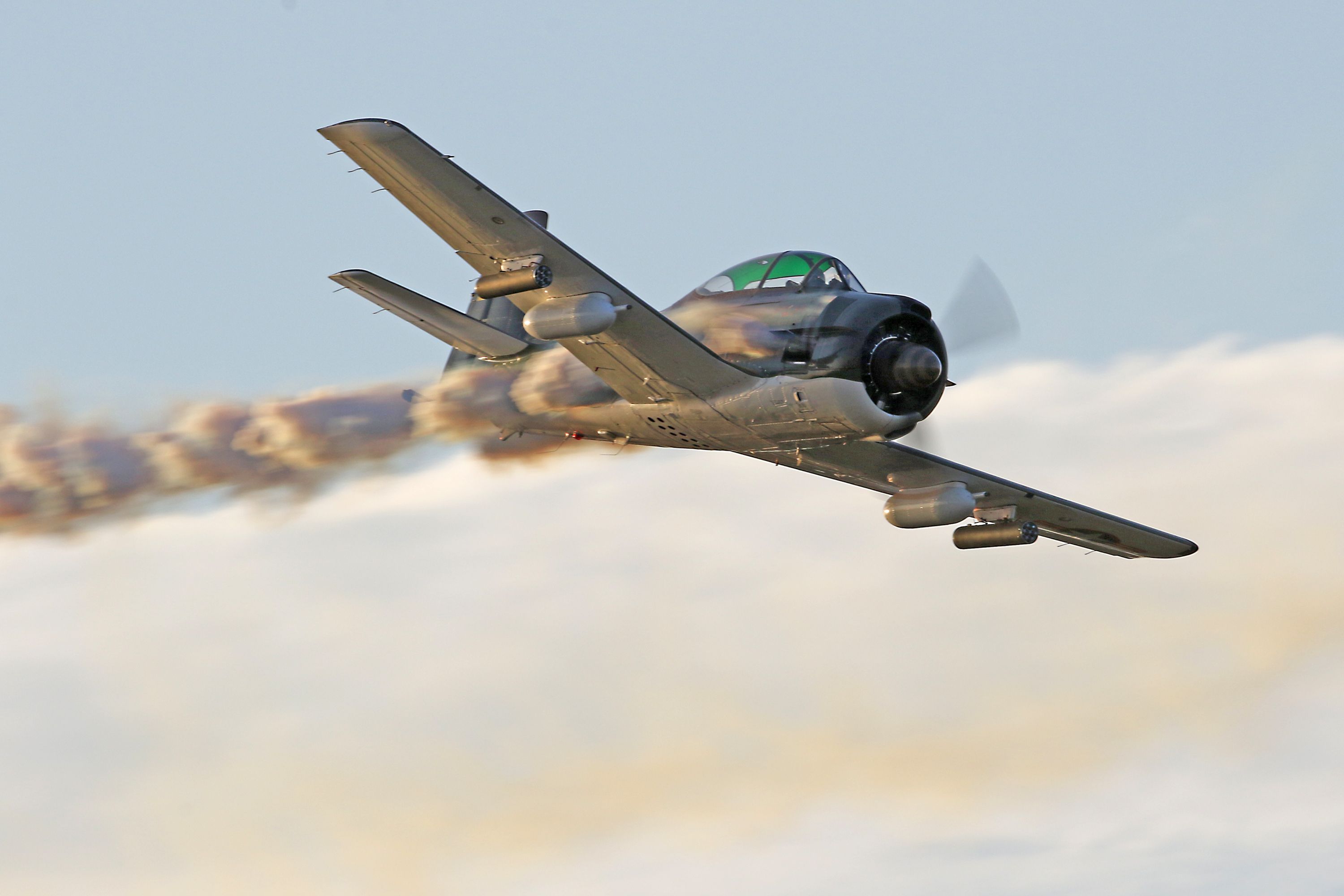 Vintage Fighter Plane in Flight with Smoke Trails · Free Stock Photo