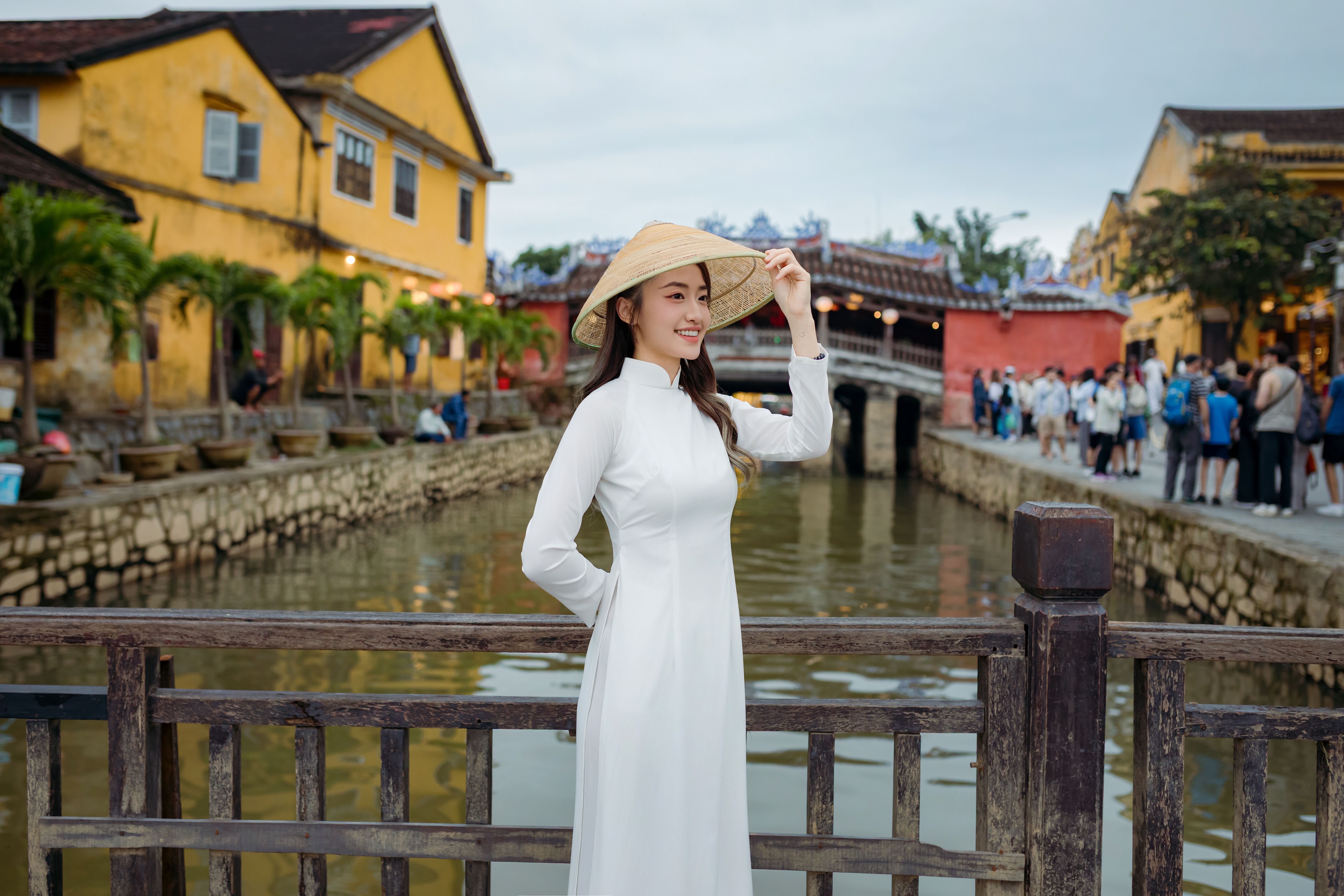 Woman in Áo dài at Japanese Bridge, Hội An · Free Stock Photo