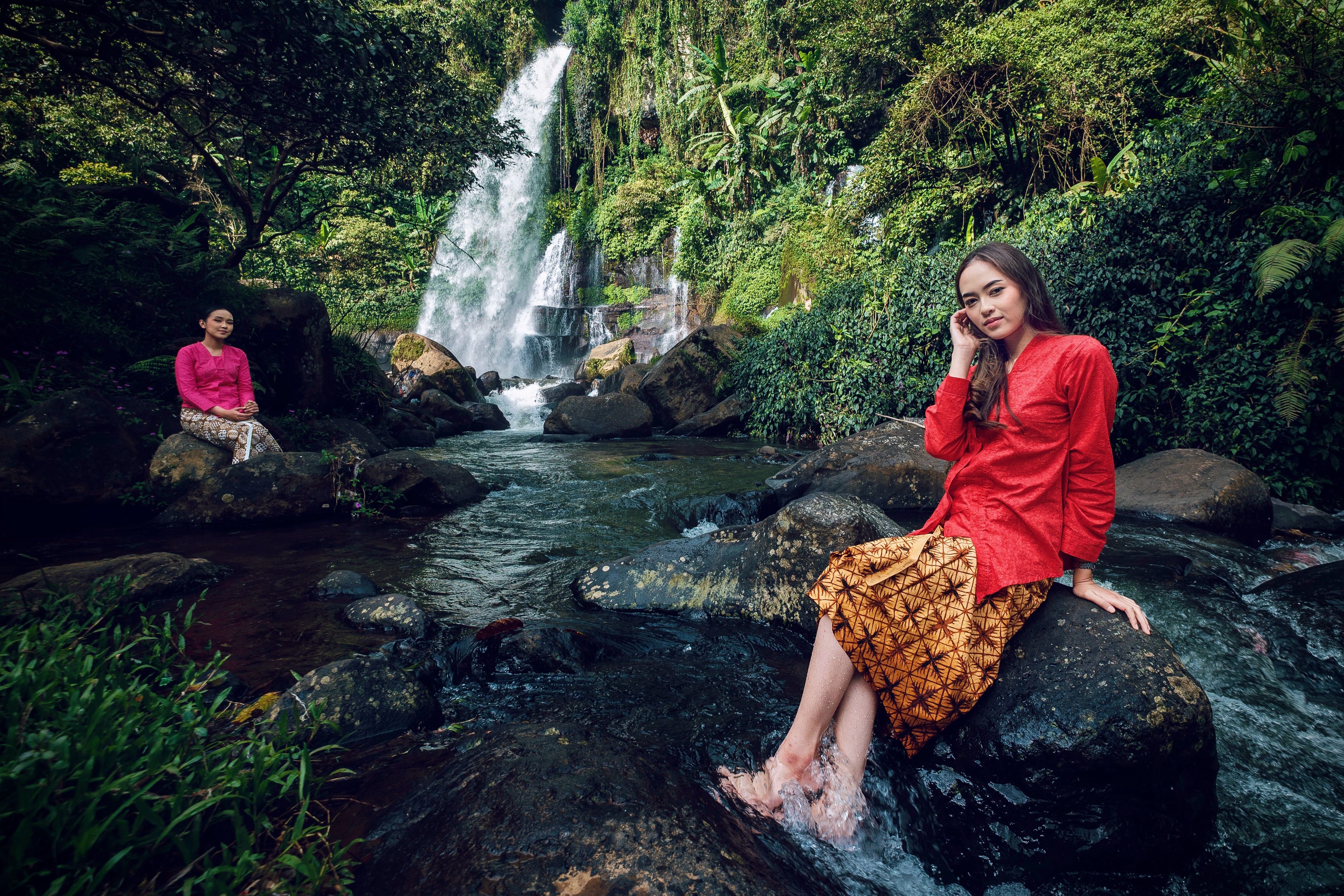 Serene Waterfall Landscape with Women in Traditional Attire · Free ...
