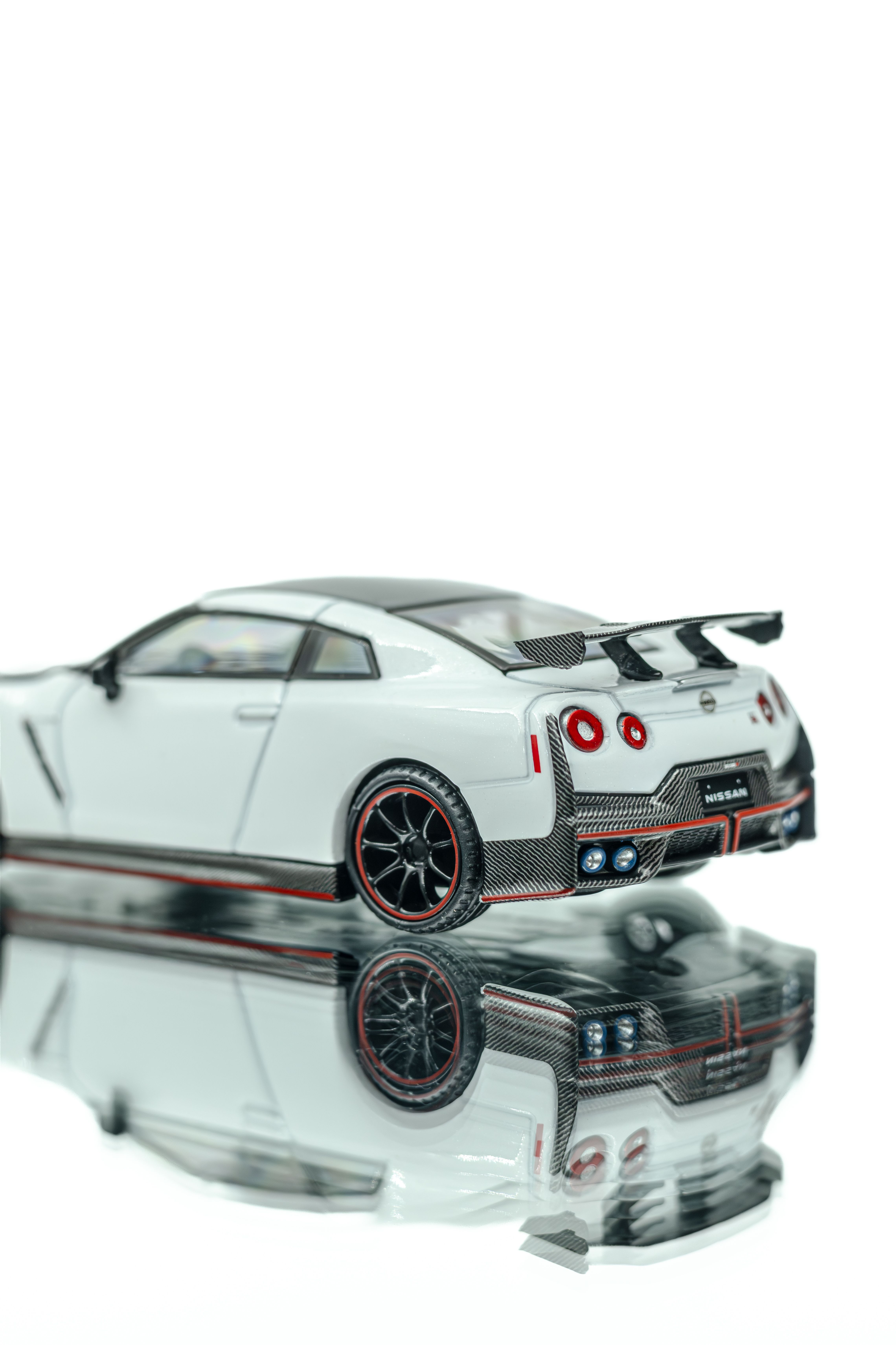 Model Car on Reflective Surface Captured Close Up · Free Stock Photo