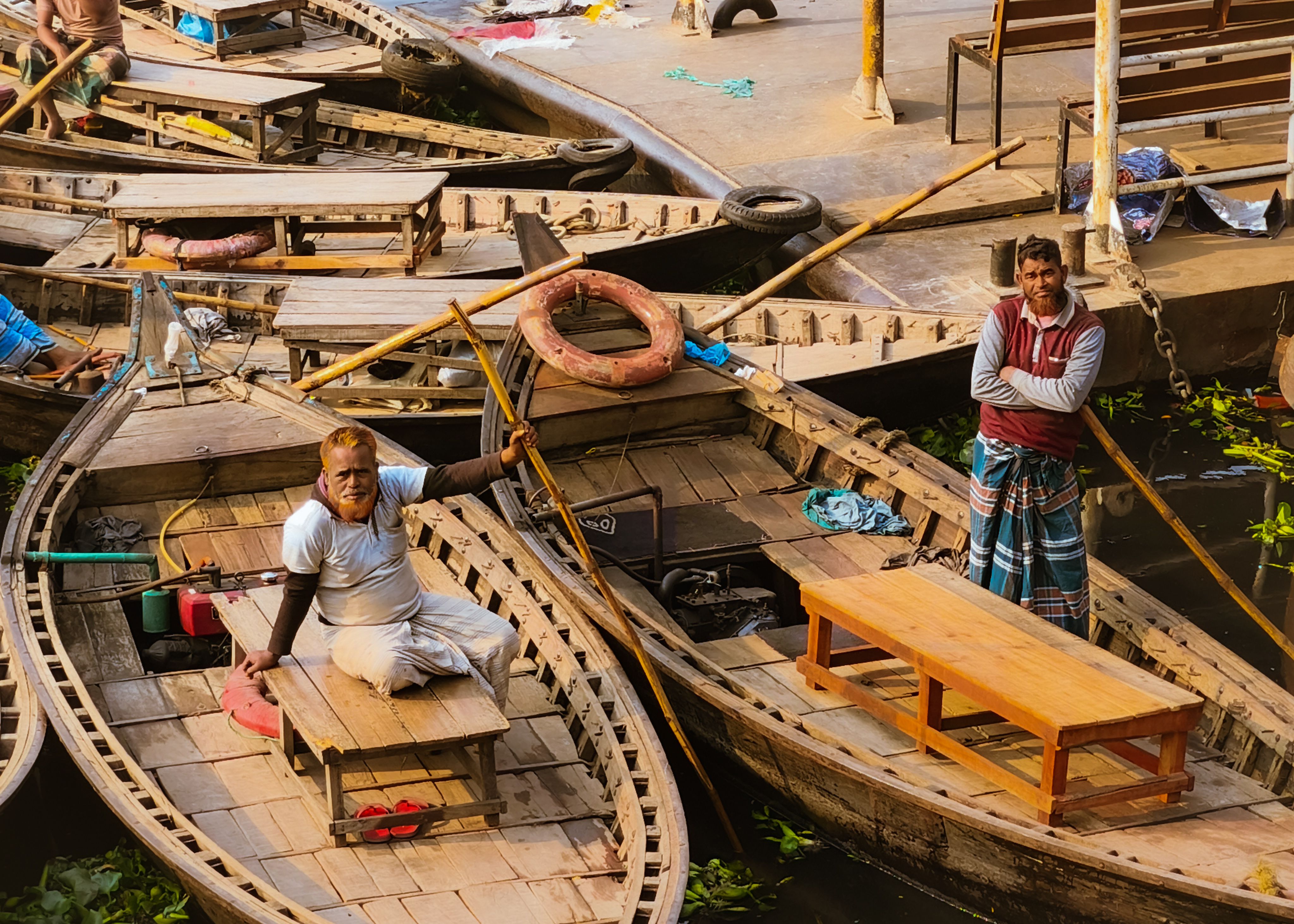 Traditional Boats and Local Men at Riverbank · Free Stock Photo