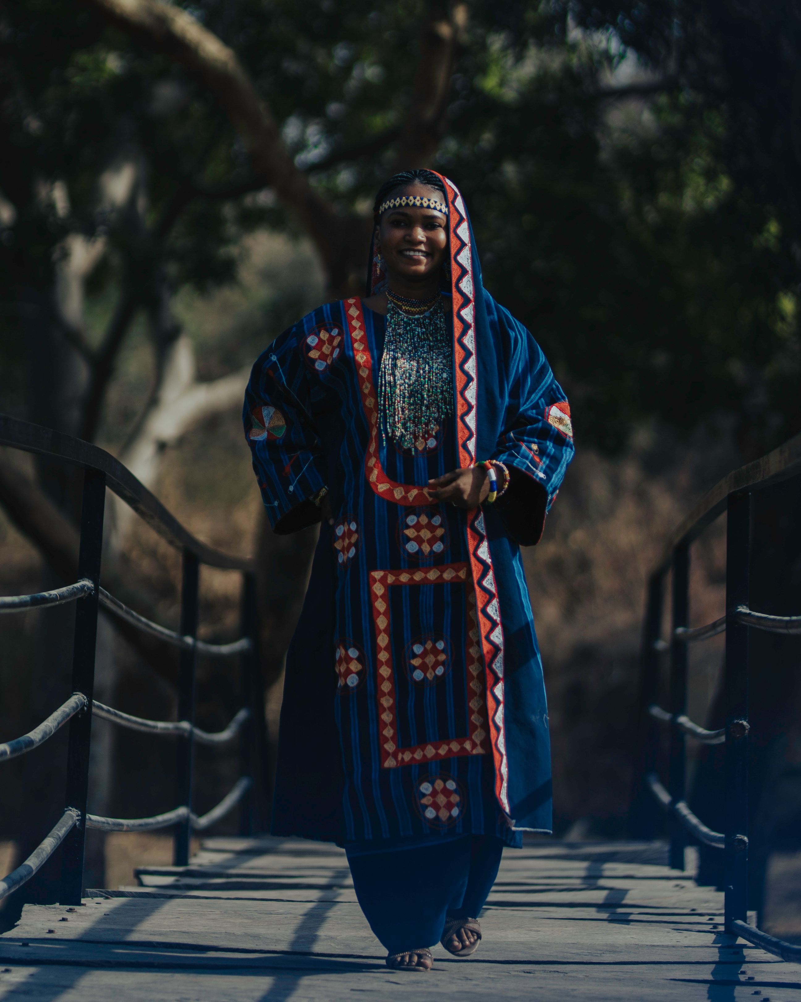 Beautiful Traditional Outfit on Wooden Bridge · Free Stock Photo