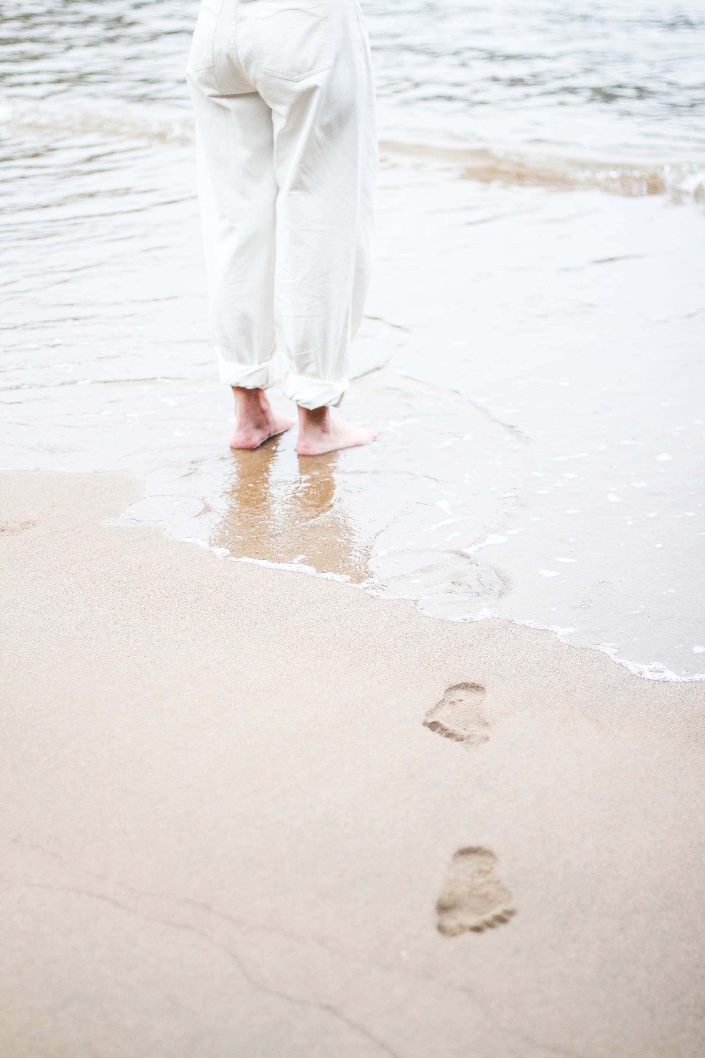 Woman In White Dress Walking Along Sandy Beach Photos, Download The ...
