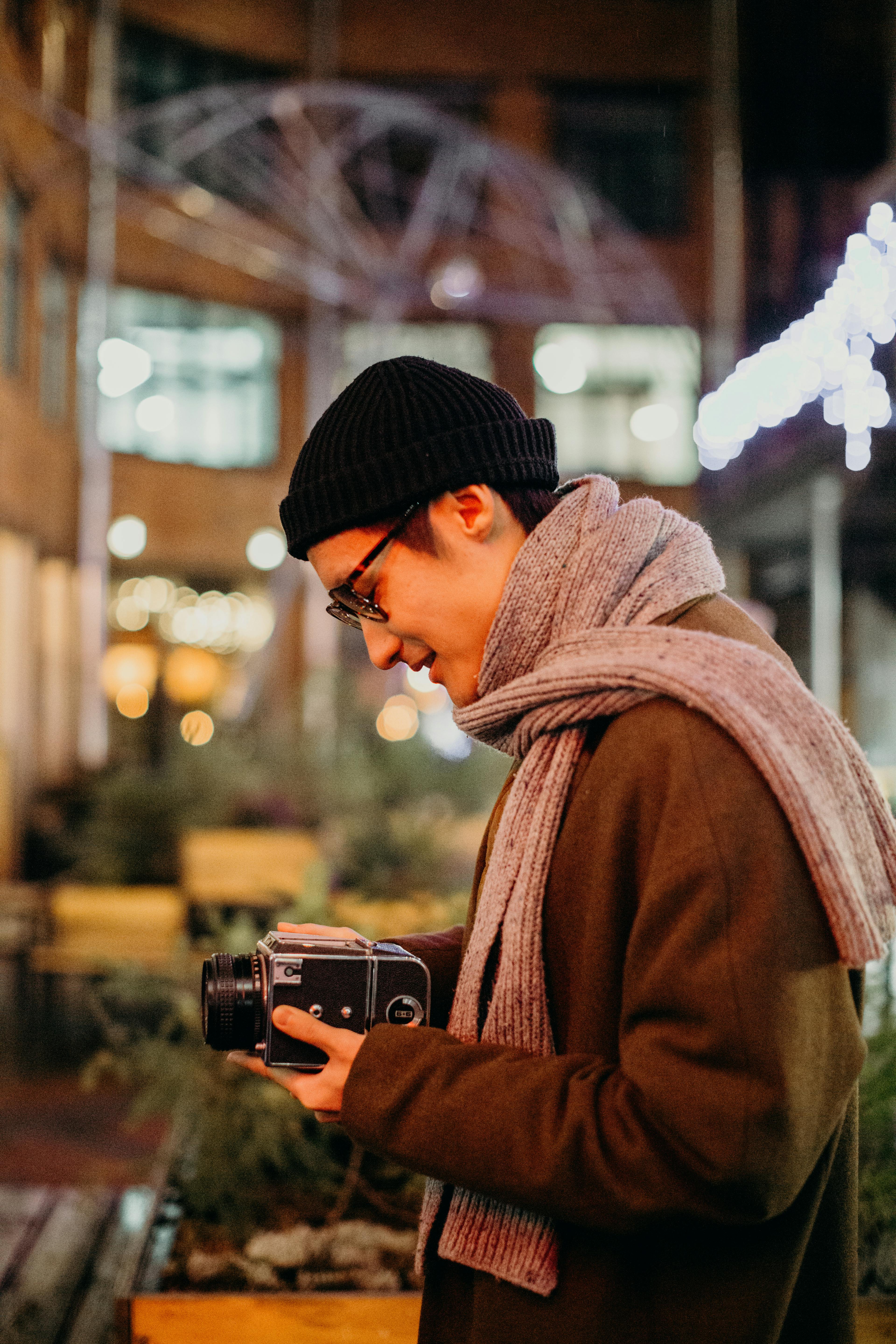 Man With Camera Between His Hands · Free Stock Photo