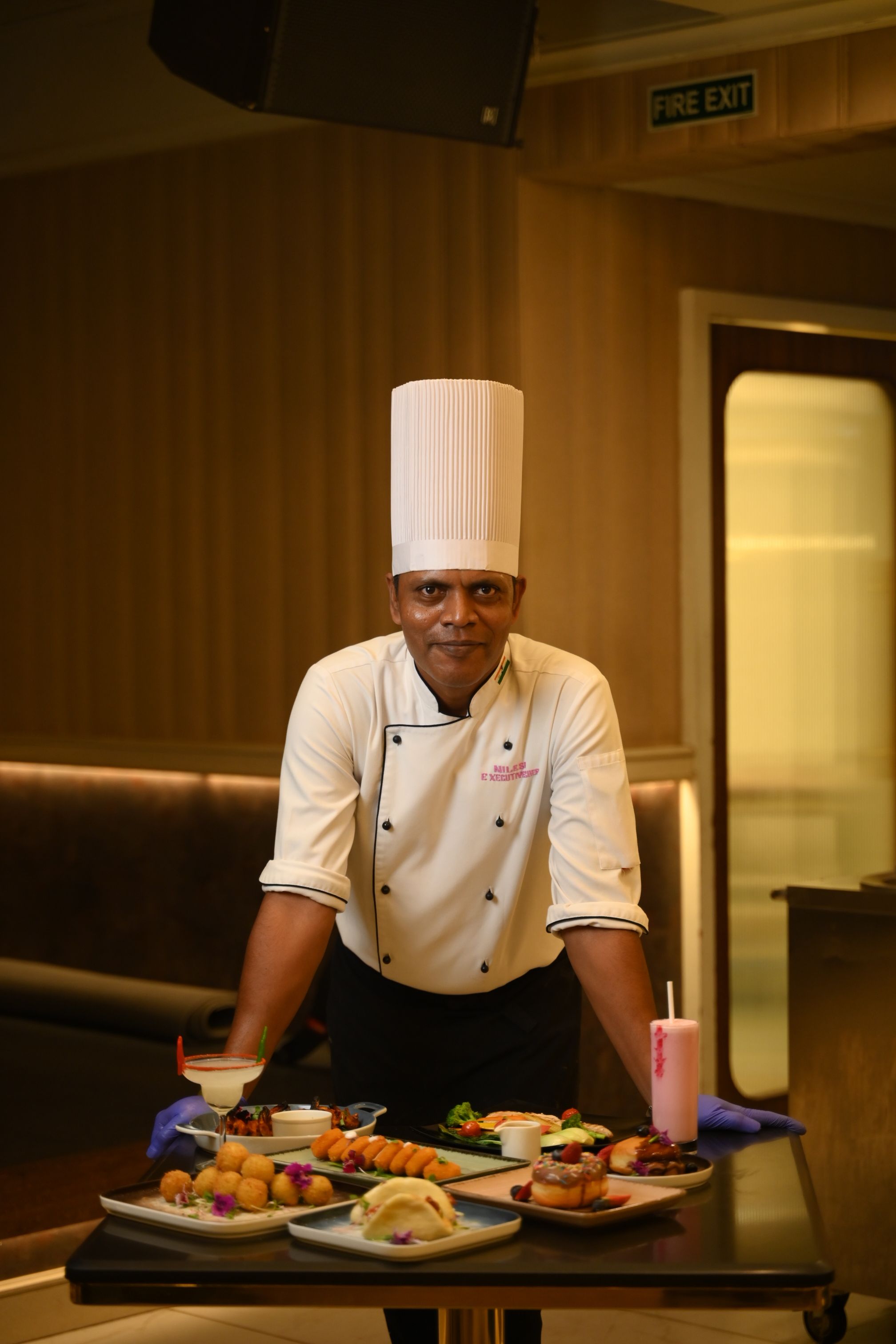 Chef in Elegant Goa Restaurant with Gourmet Dishes · Free Stock Photo