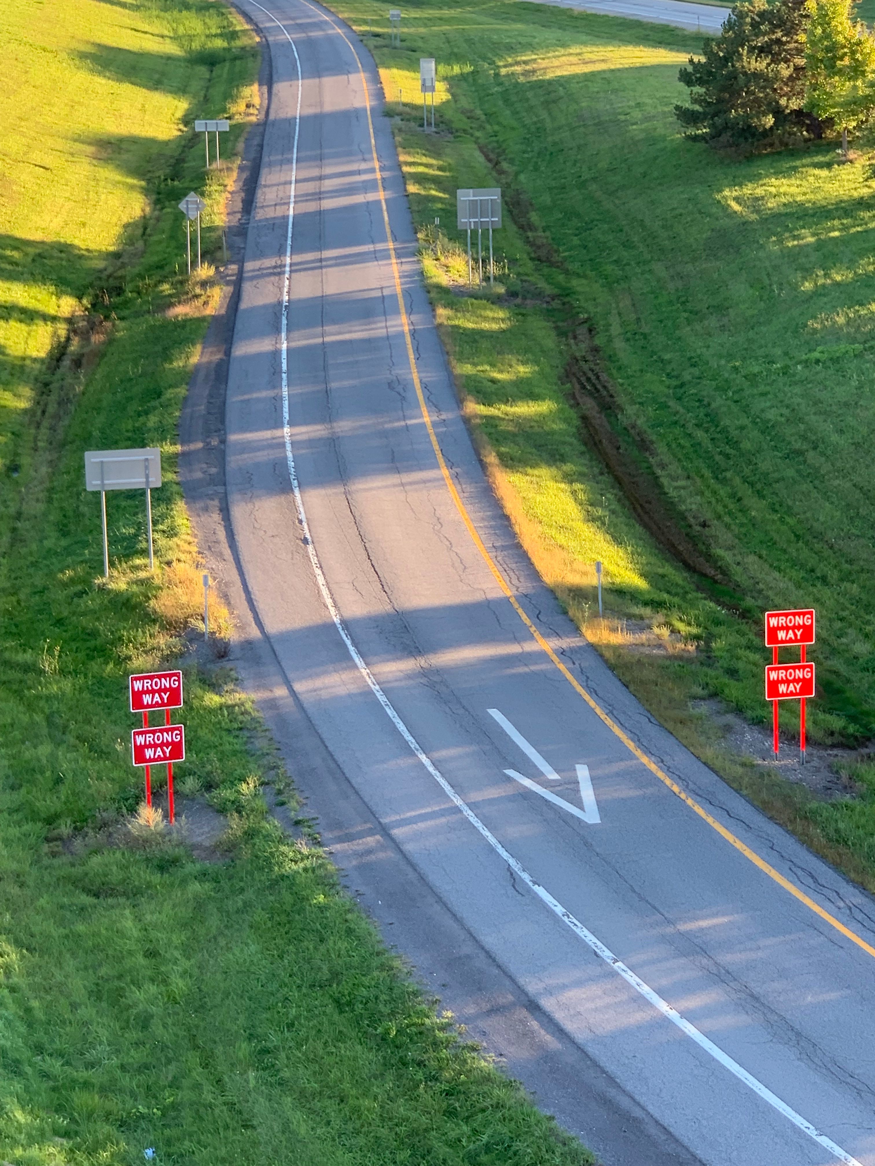 Aerial View of a Wrong Way Road Sign on Highway · Free Stock Photo