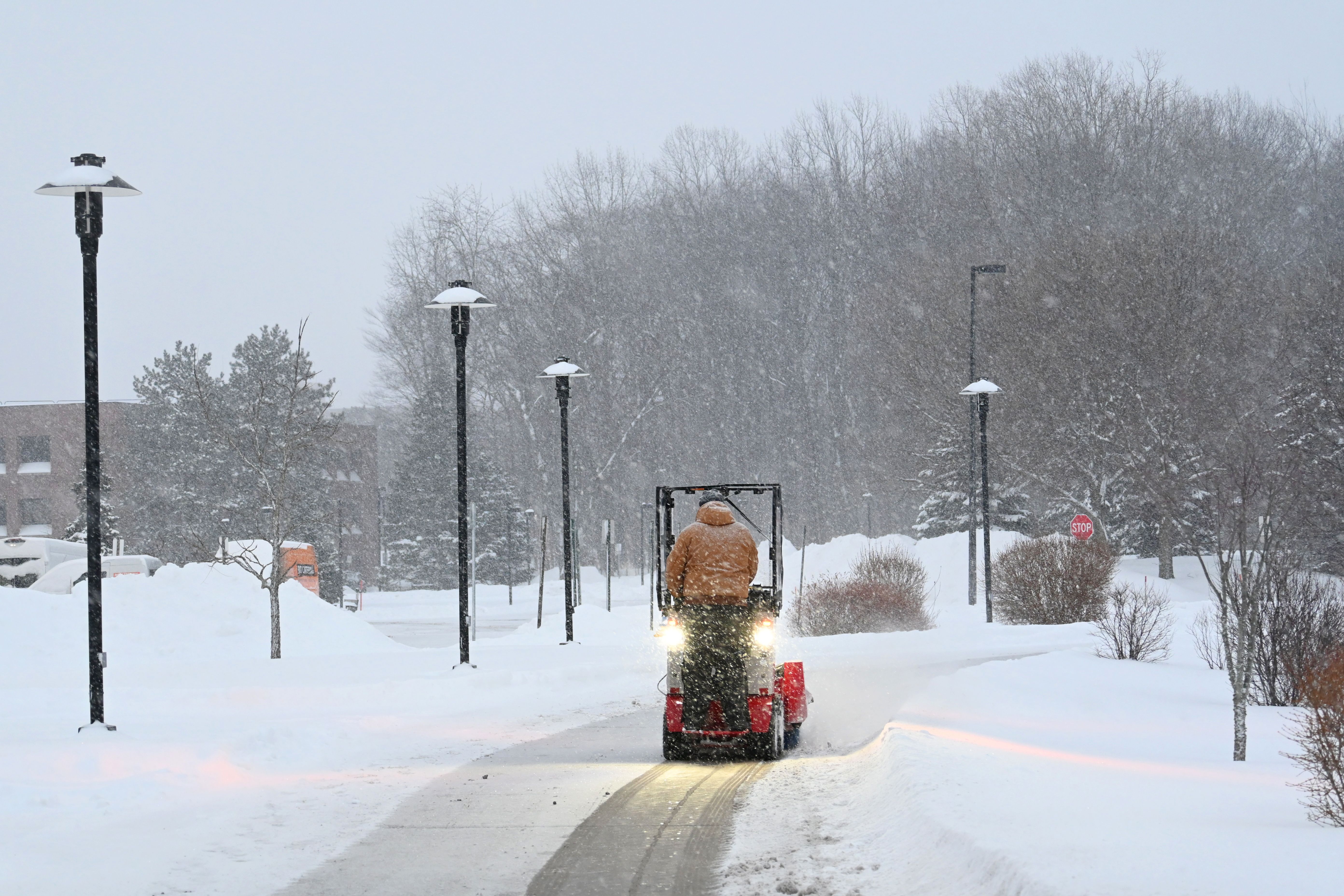 Snow Plow Clearing Path During Winter Snowfall · Free Stock Photo