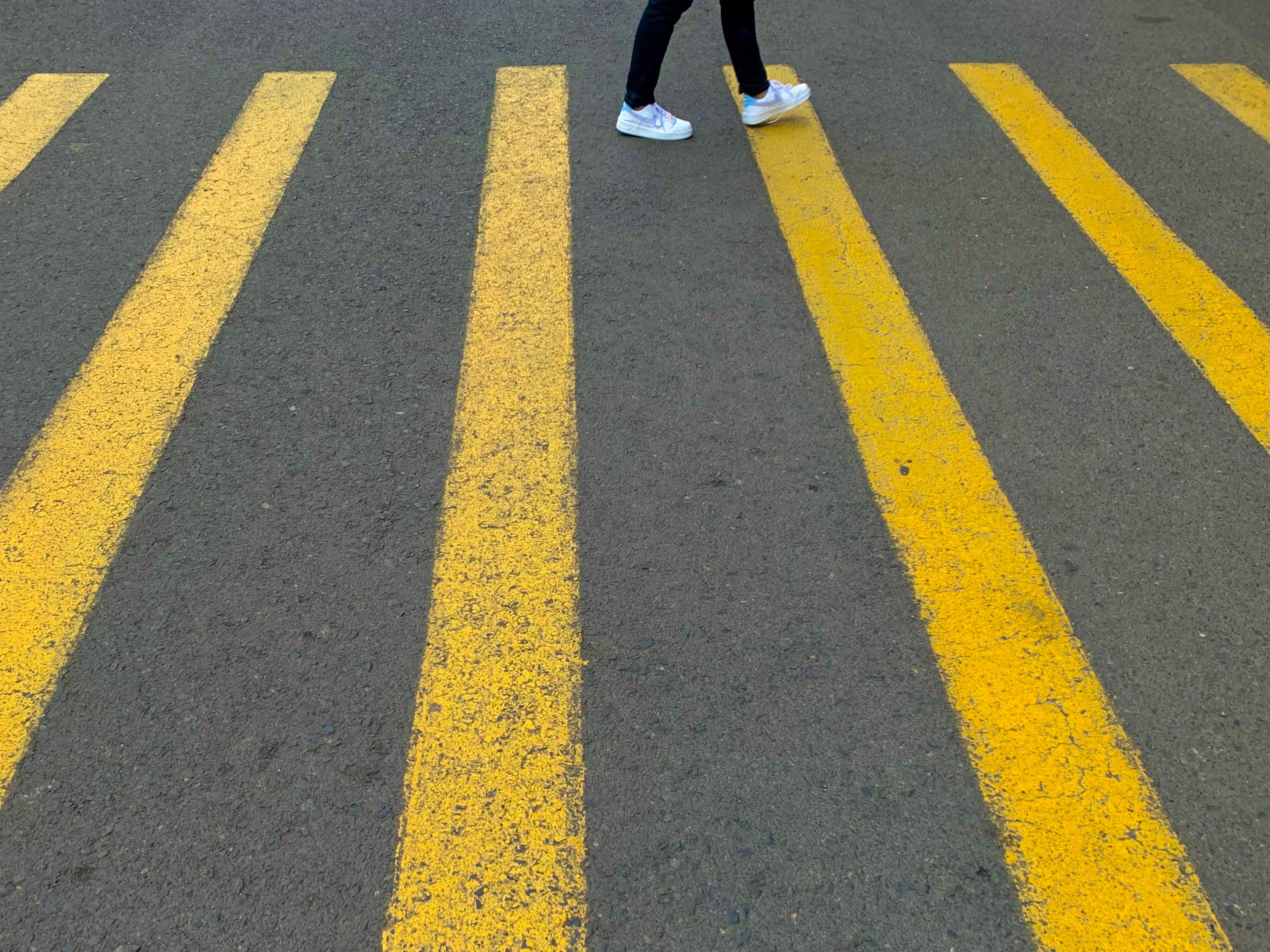 Urban Crosswalk Footsteps in Bright Yellow · Free Stock Photo