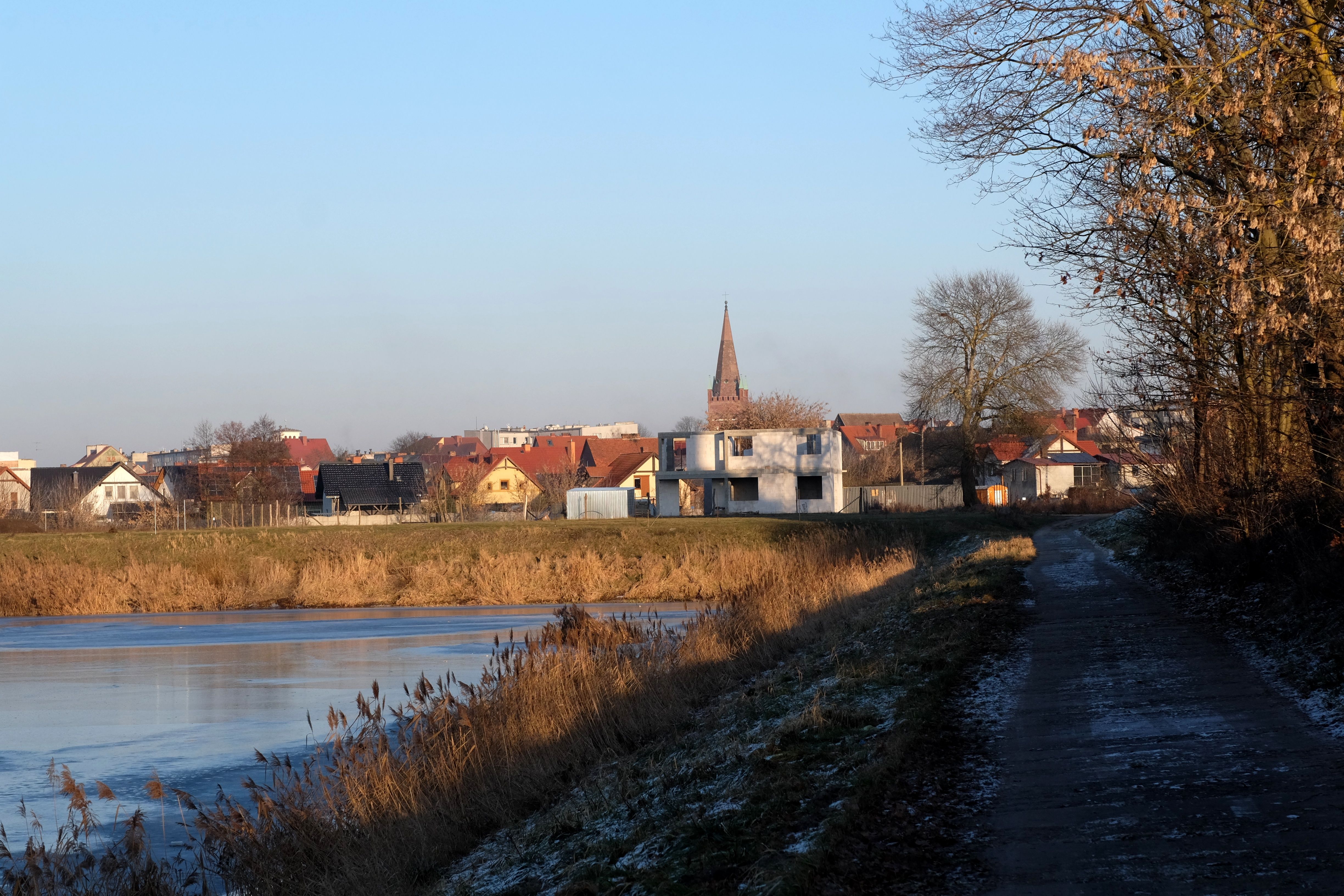 Charming Village Winter Landscape with Church Spire · Free Stock Photo