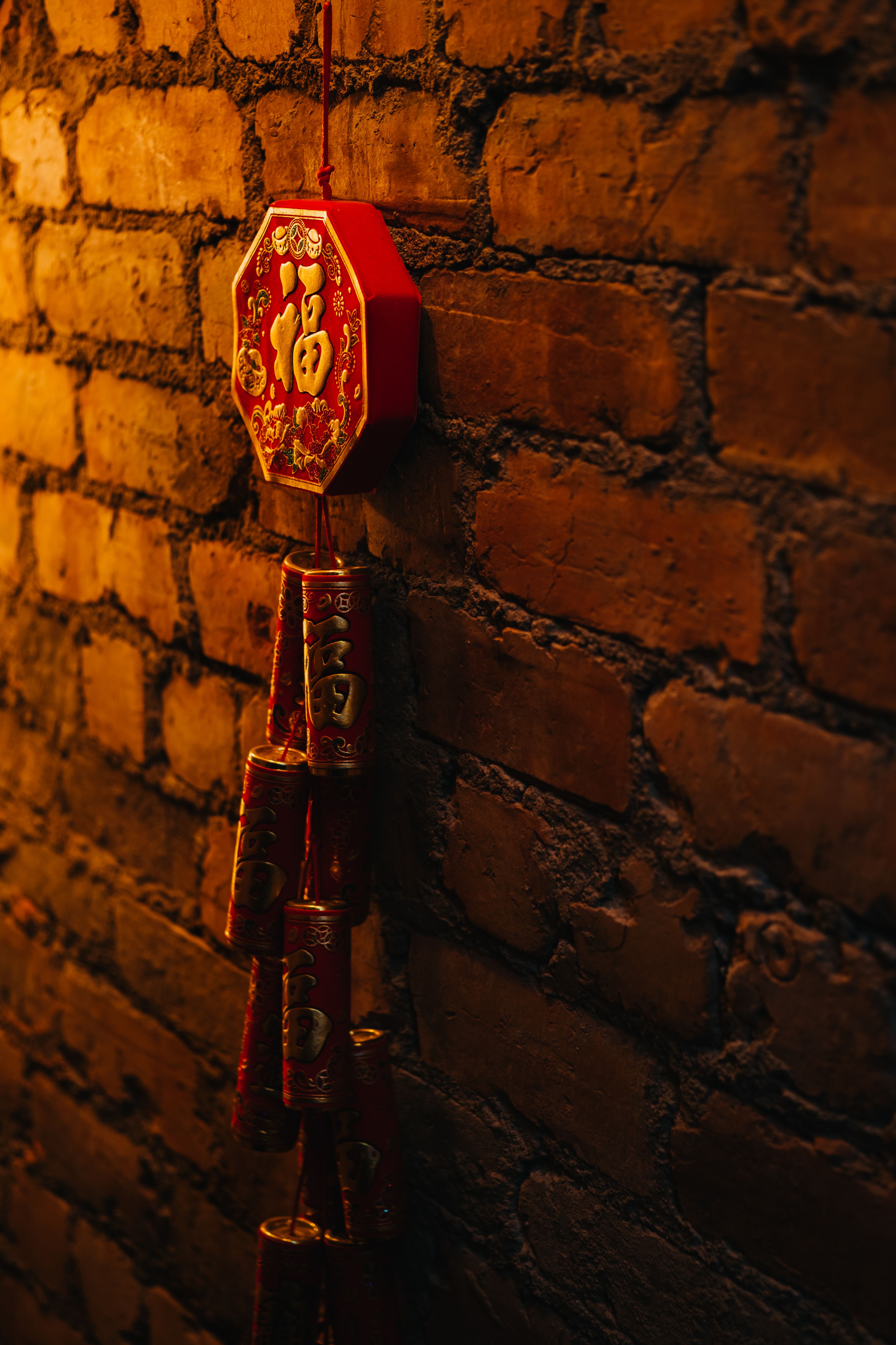 Chinese New Year Firecrackers on Rustic Wall · Free Stock Photo
