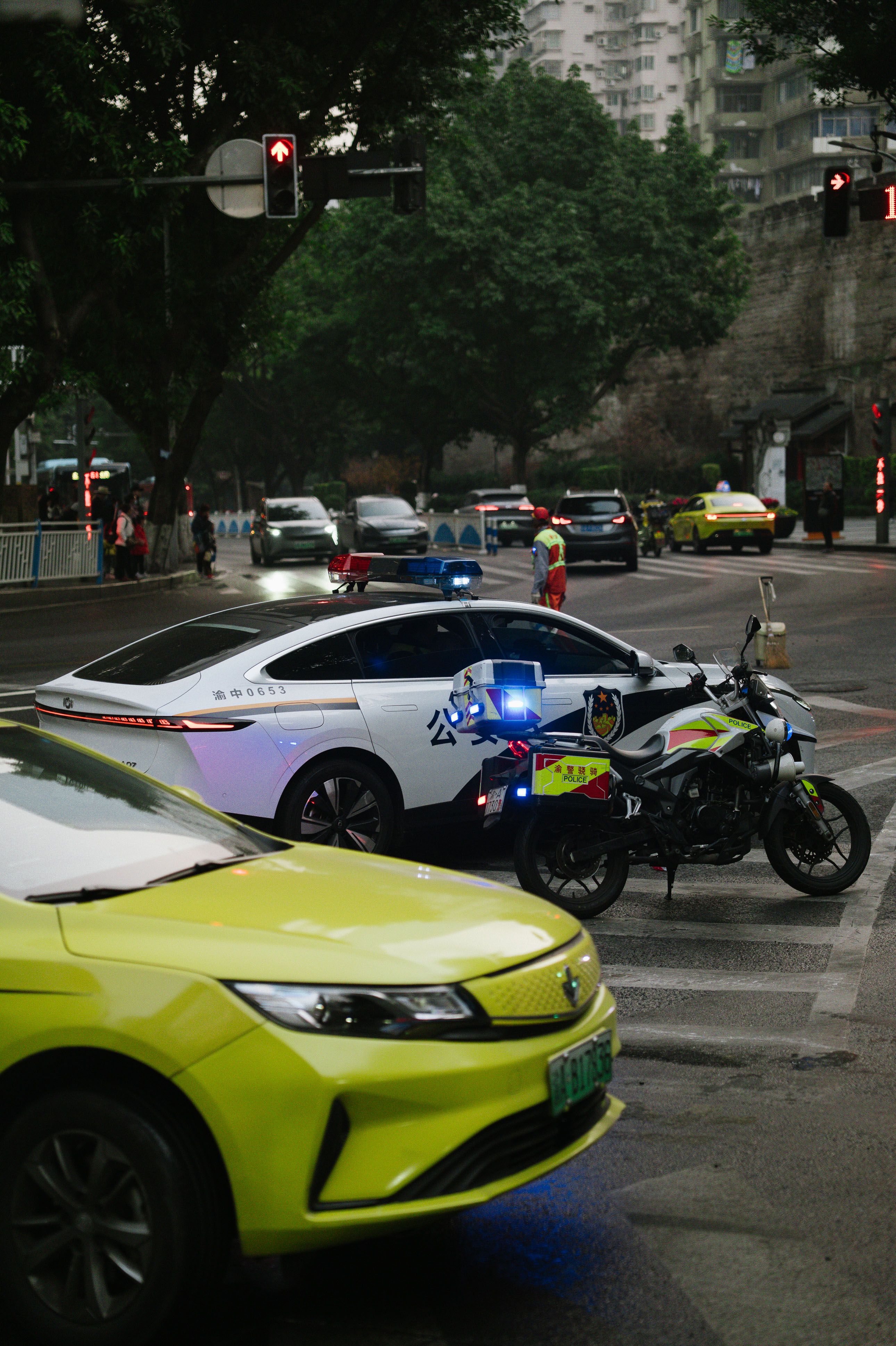 Traffic Scene with Police Vehicles in Urban Setting · Free Stock Photo