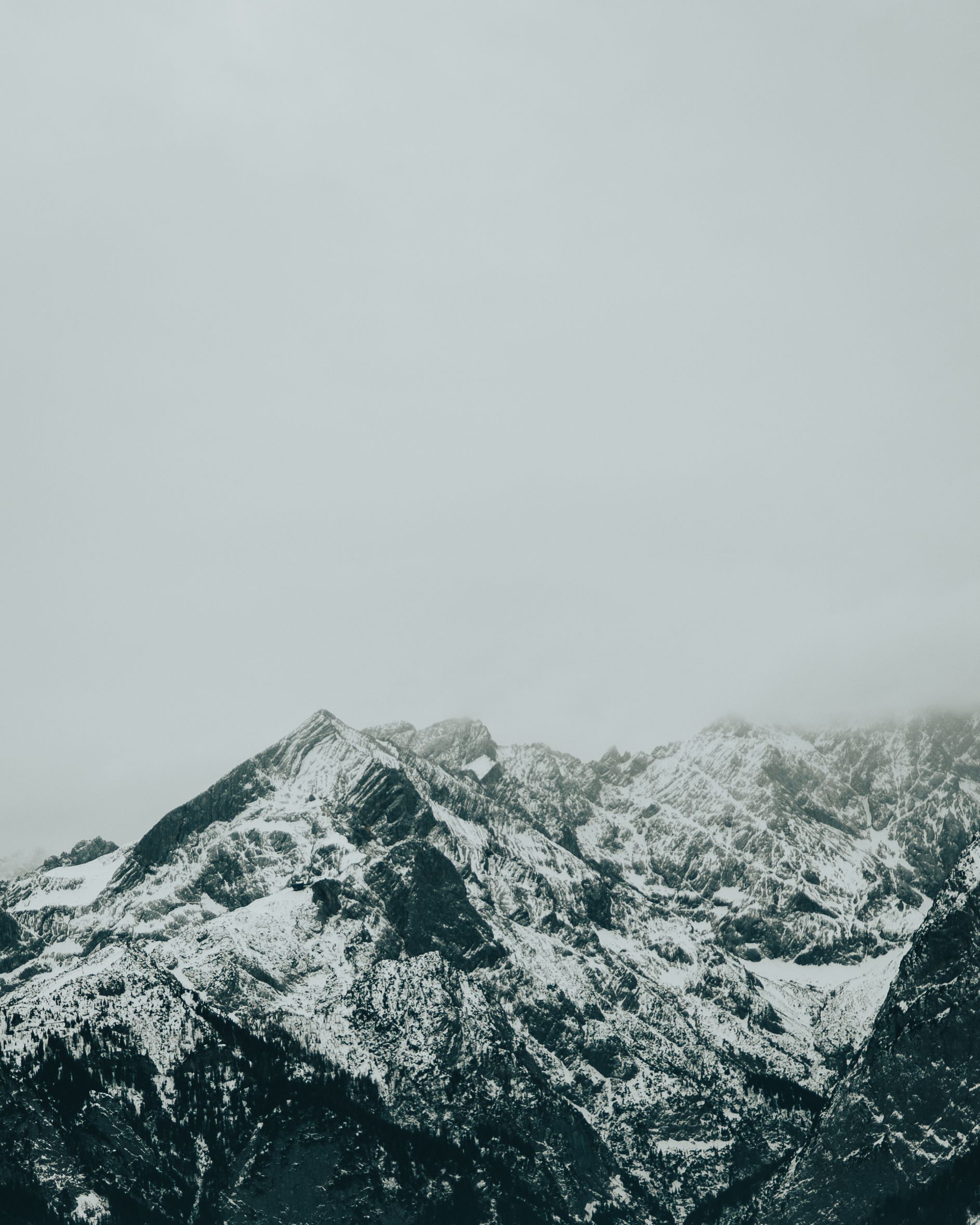 Snow-Covered Alps Under Overcast Skies · Free Stock Photo