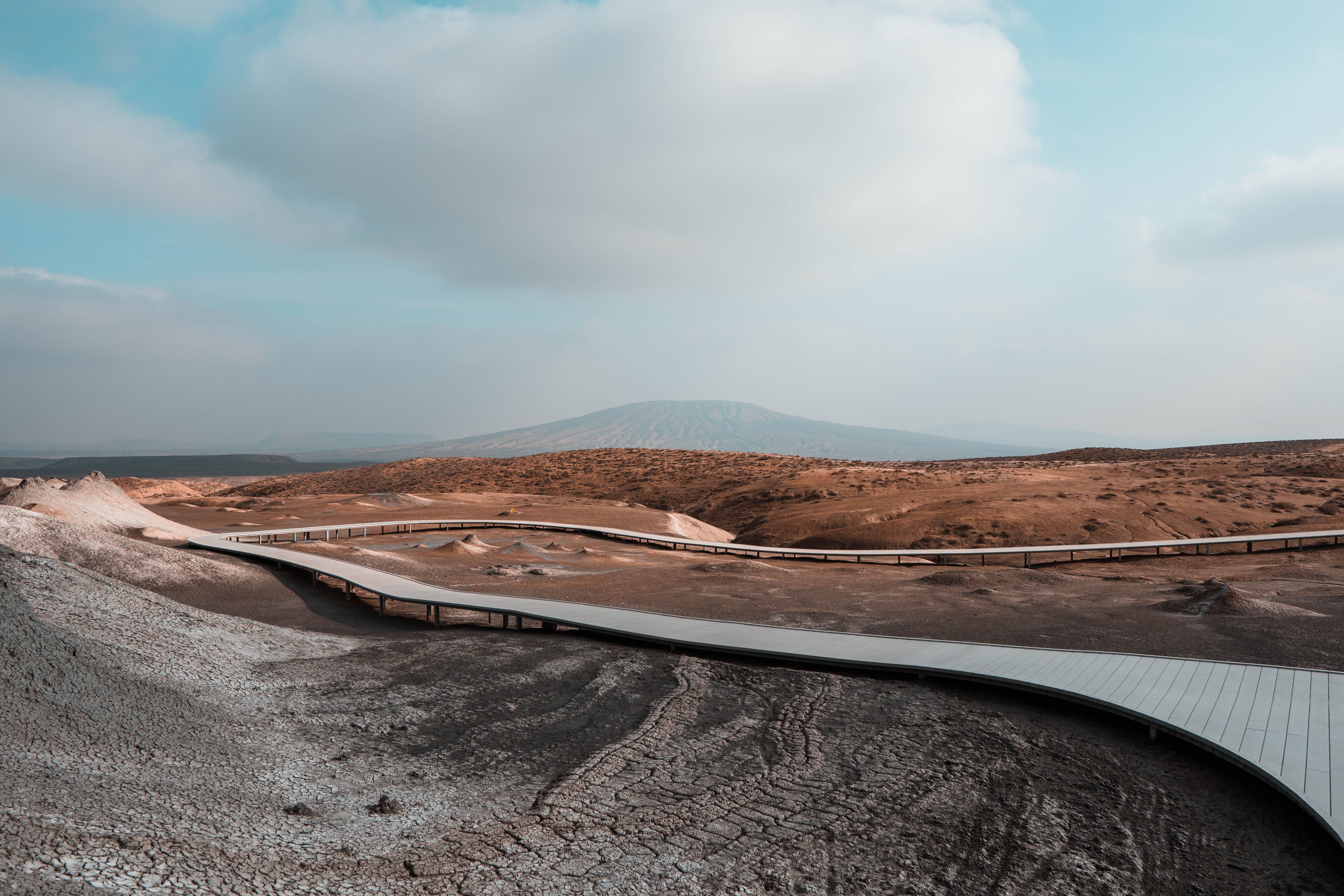 Curved Wooden Pathway in Arid Landscape · Free Stock Photo