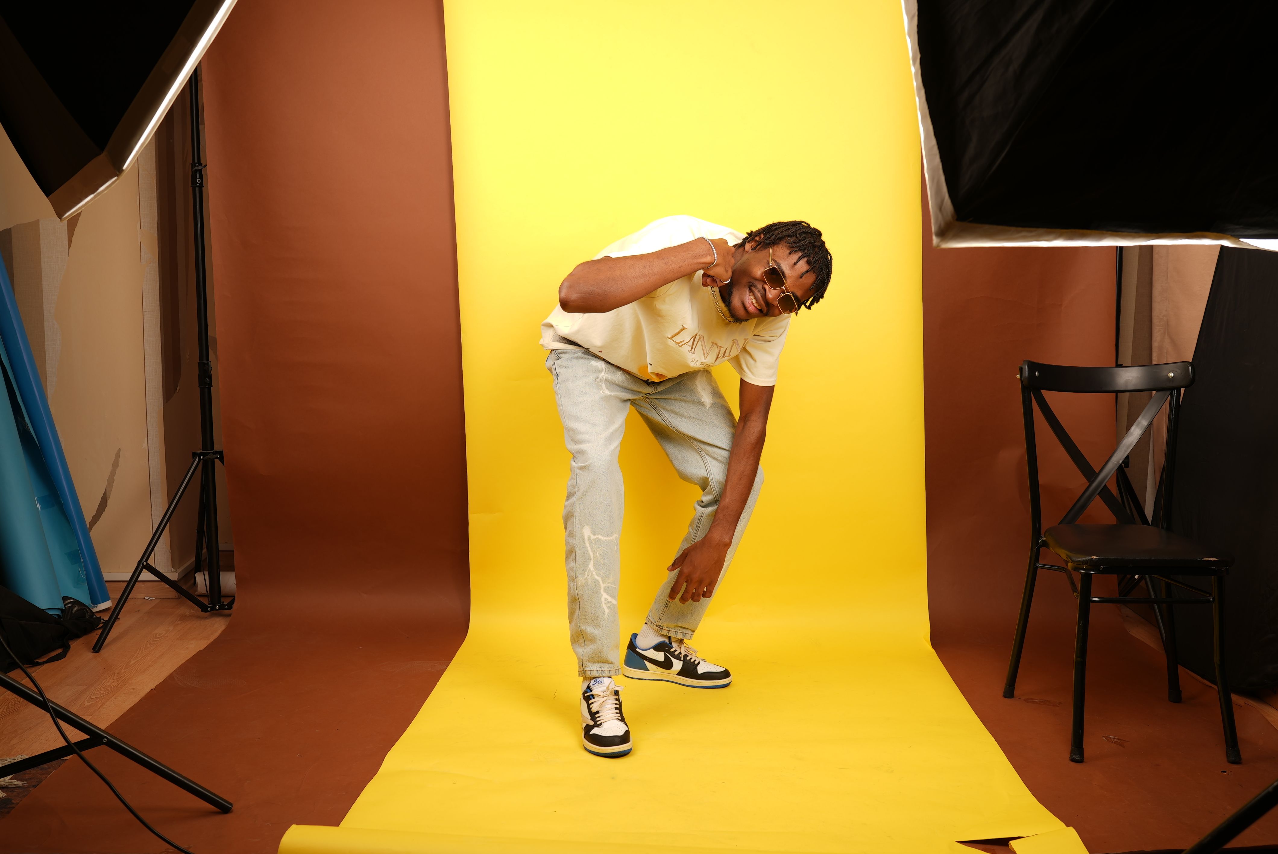 Stylish Man Posing in Photography Studio Setup · Free Stock Photo