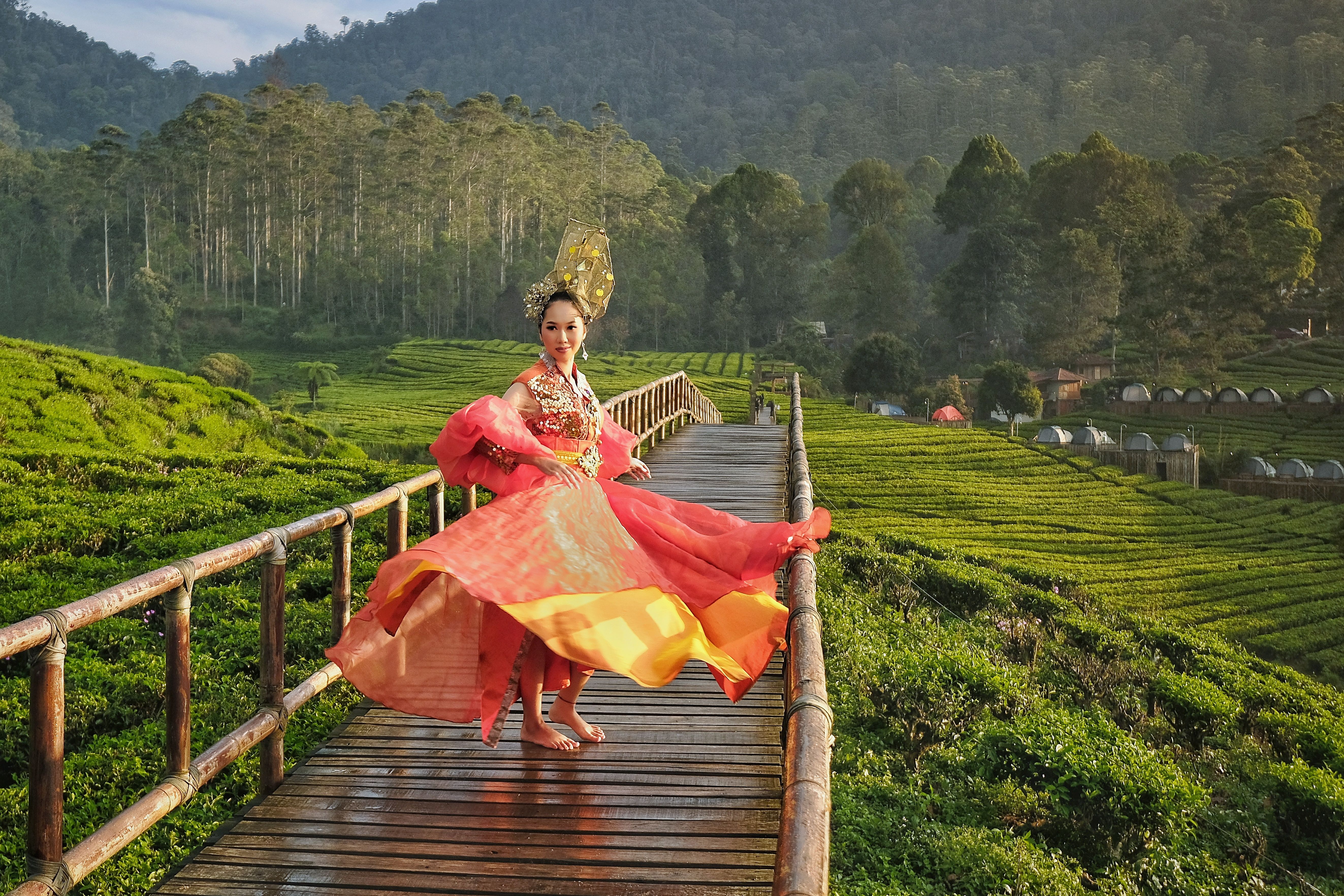 Woman in Traditional Dress Dancing on Scenic Bridge · Free Stock Photo