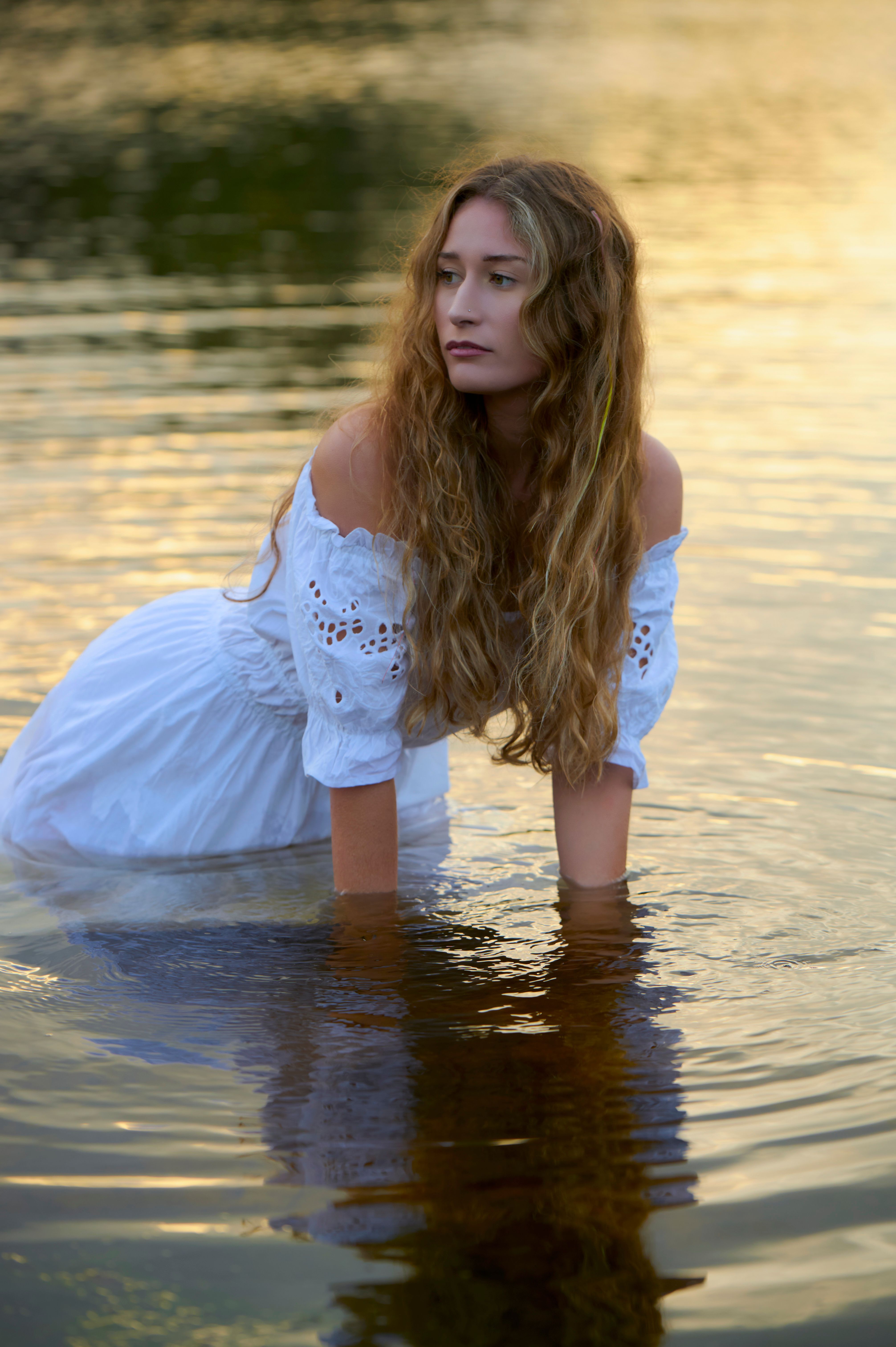 Woman Standing in Water in Wet White Dress · Free Stock Photo