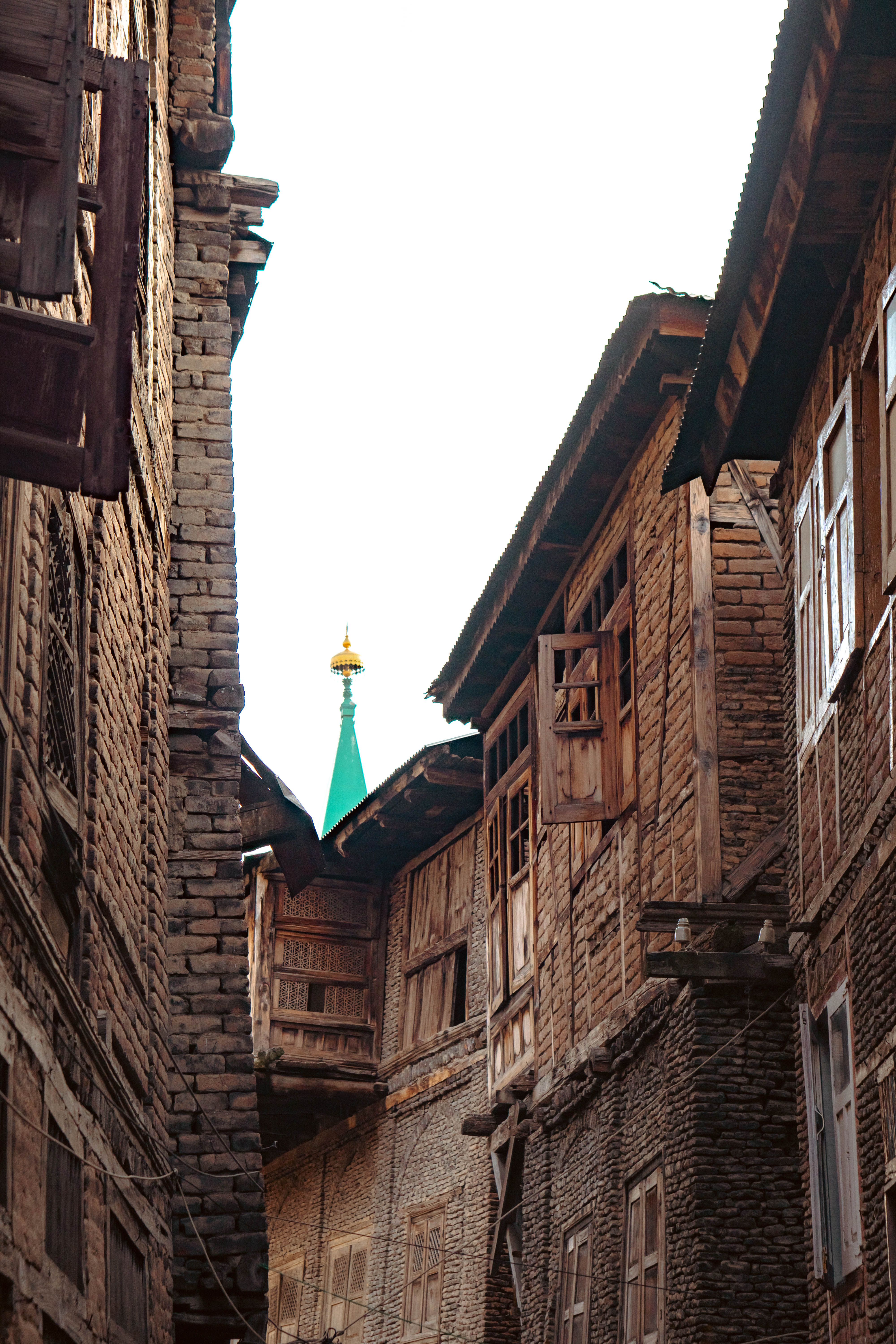 Historic Narrow Street with Rustic Wooden Architecture · Free Stock Photo