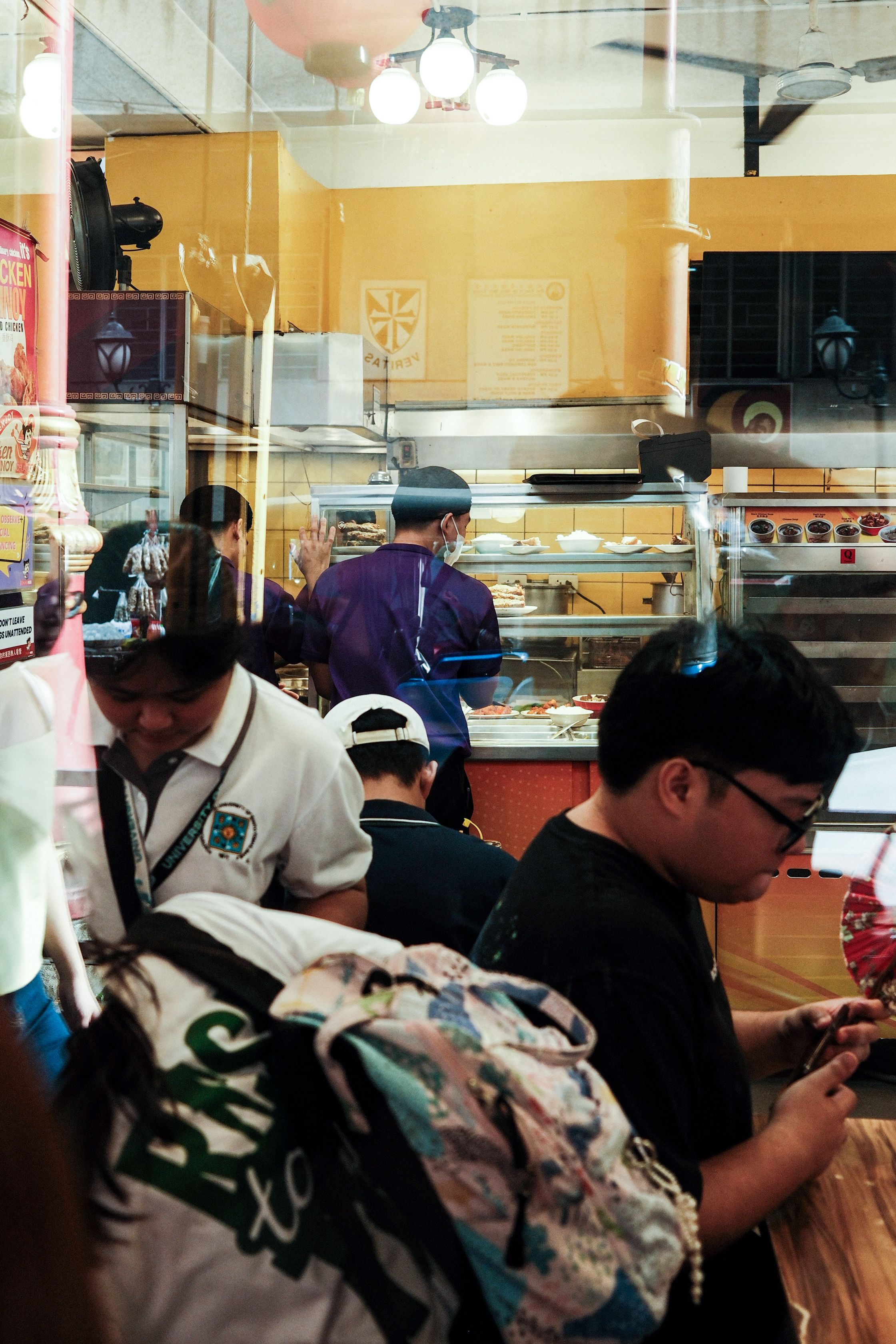 Busy Cafe Scene in Manila Captured Through Glass · Free Stock Photo