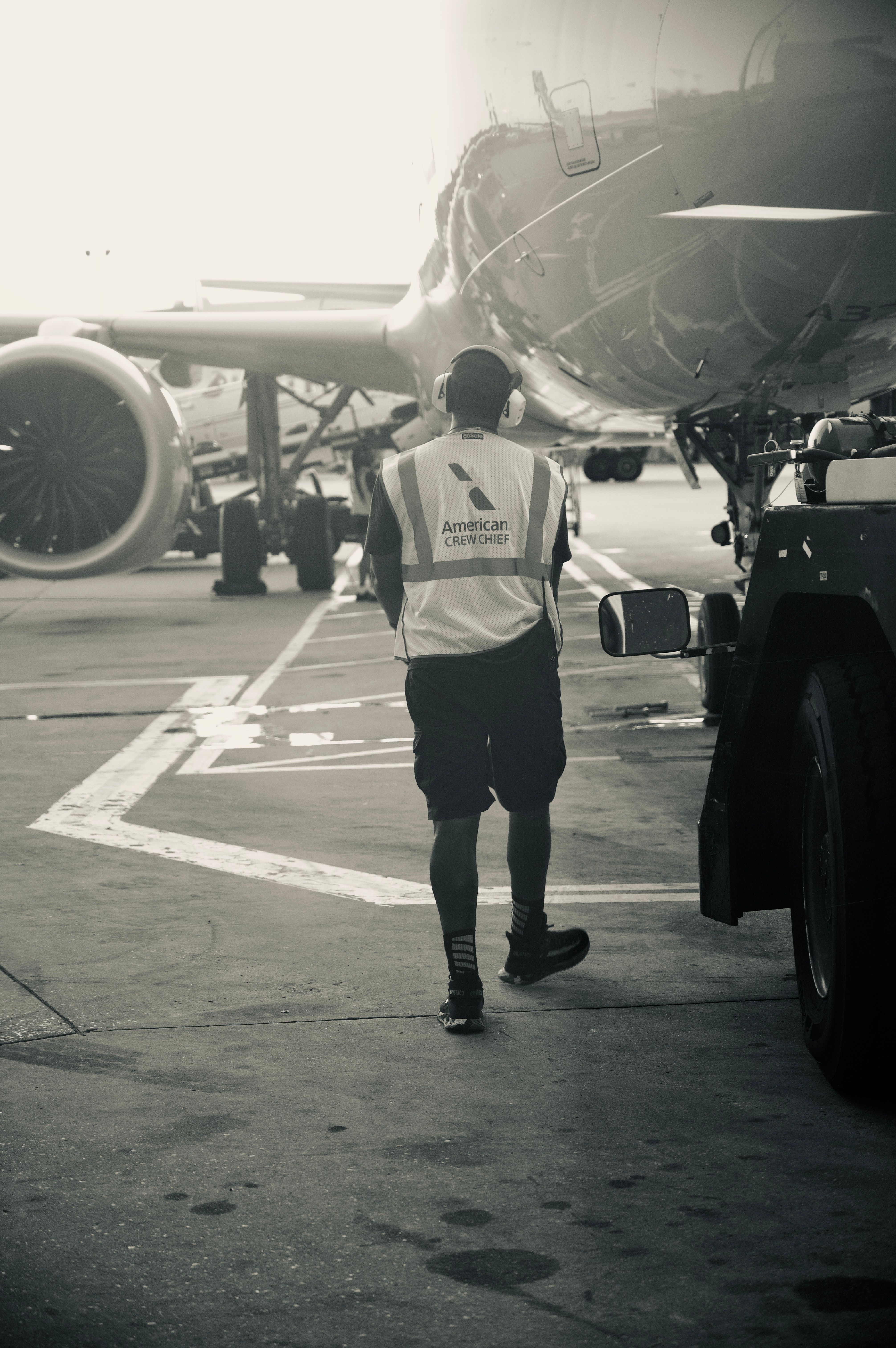 Airport Ground Crew Member Walking by Aircraft · Free Stock Photo