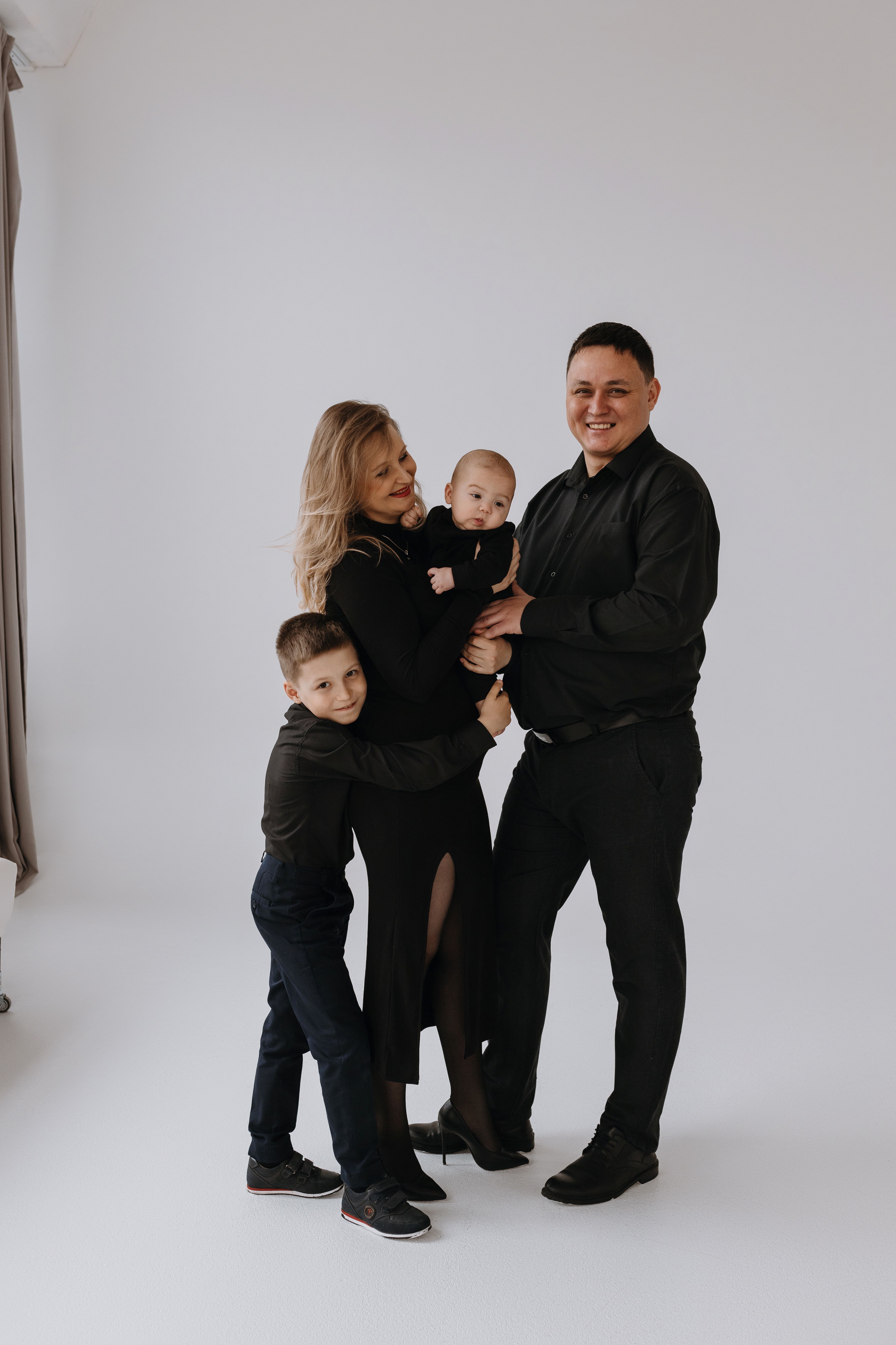 Elegant Family Portrait in Studio Setting · Free Stock Photo