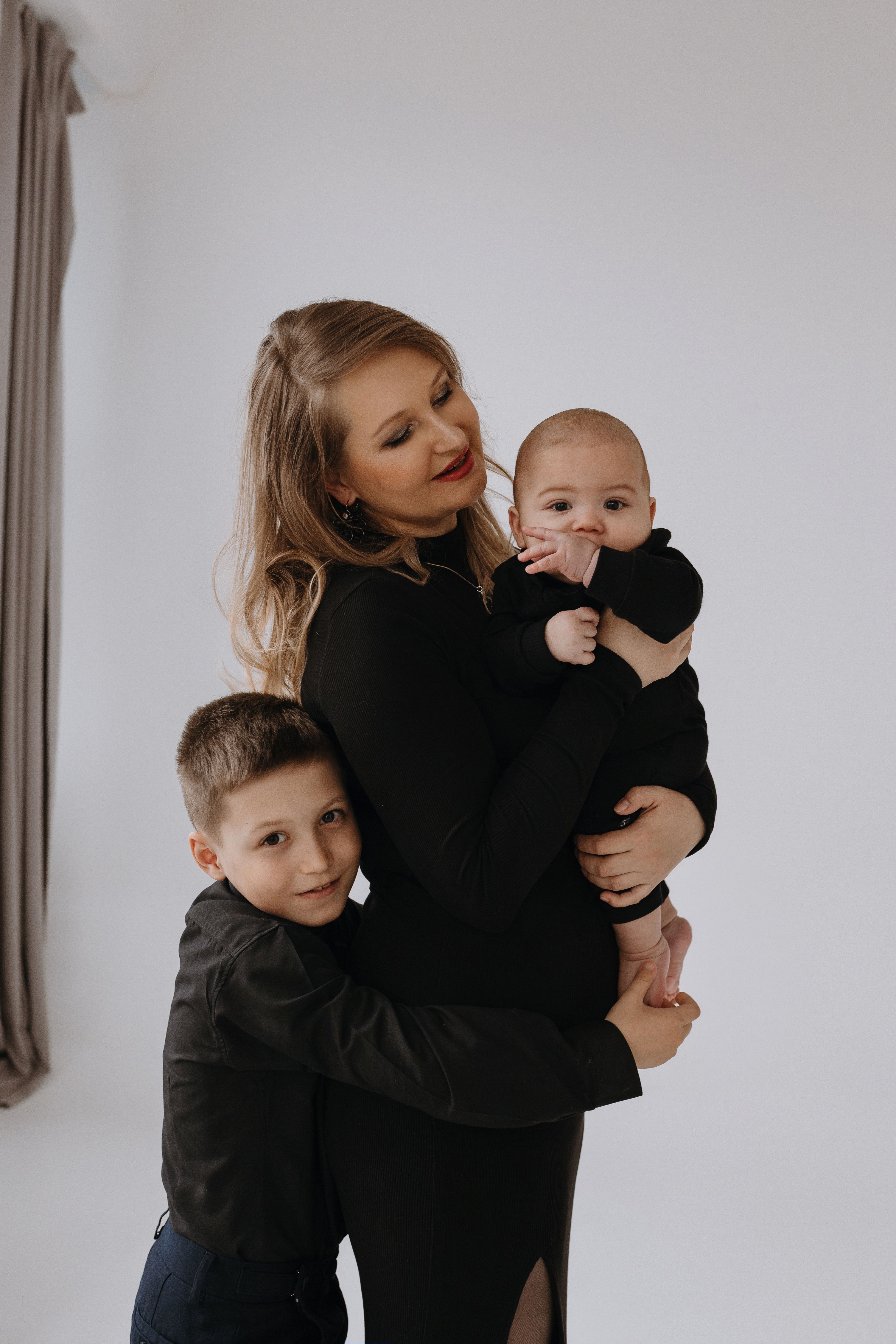 Loving Family Embrace in Simple Studio Setting · Free Stock Photo