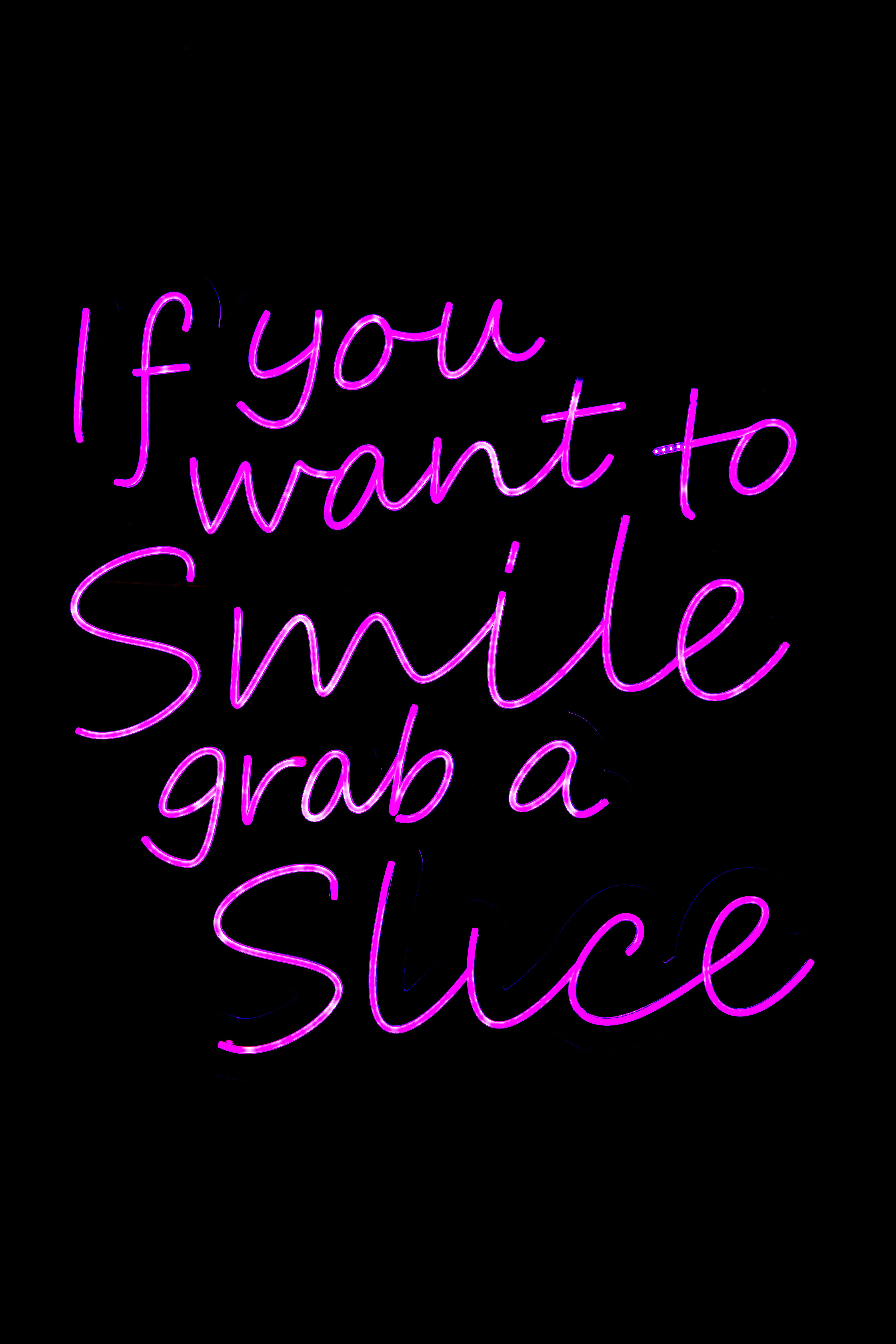 Neon Sign 'Grab a Slice' on Black Background · Free Stock Photo