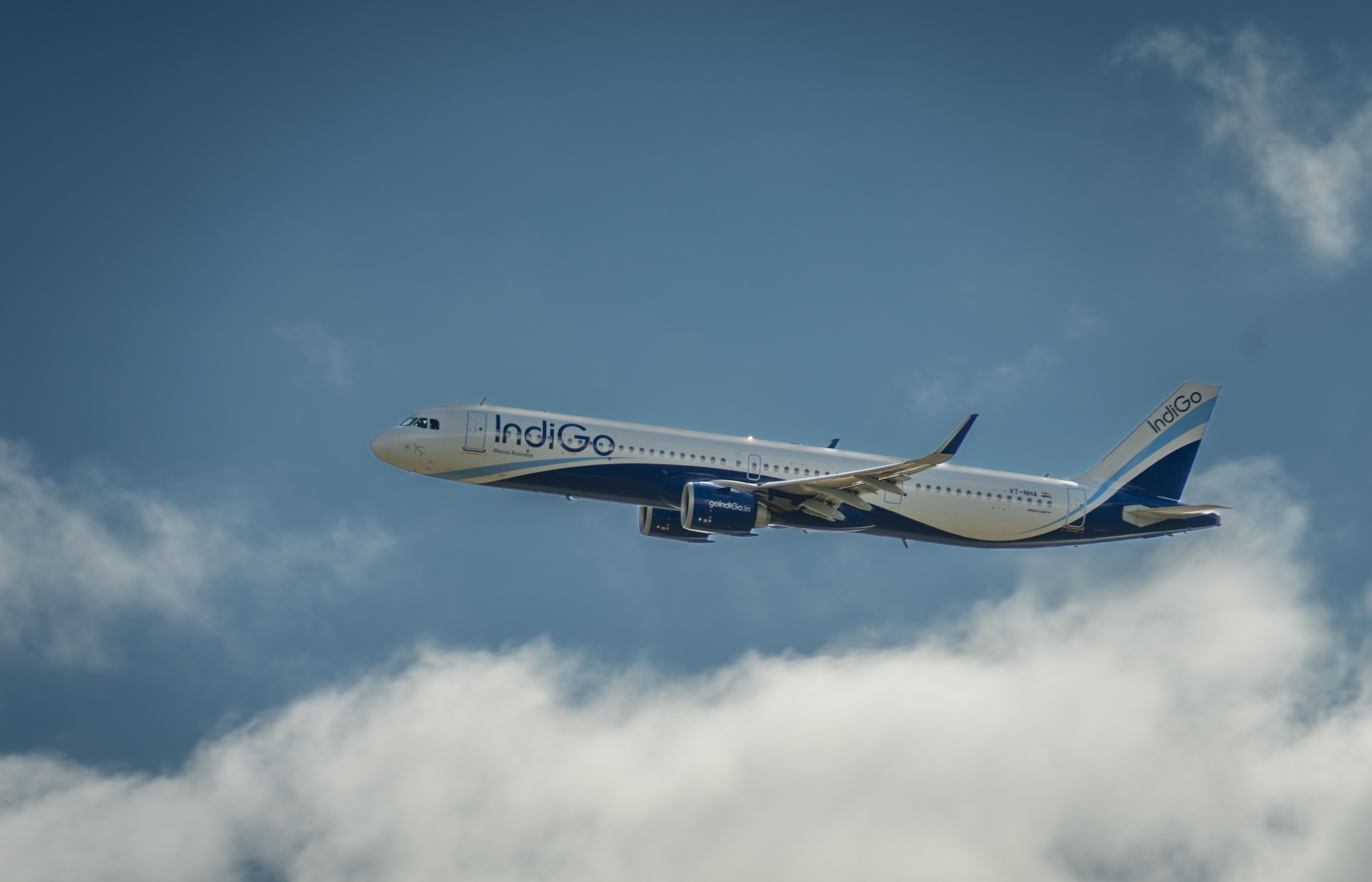 IndiGo Airplane Soars Above Clouds in Daytime Sky · Free Stock Photo