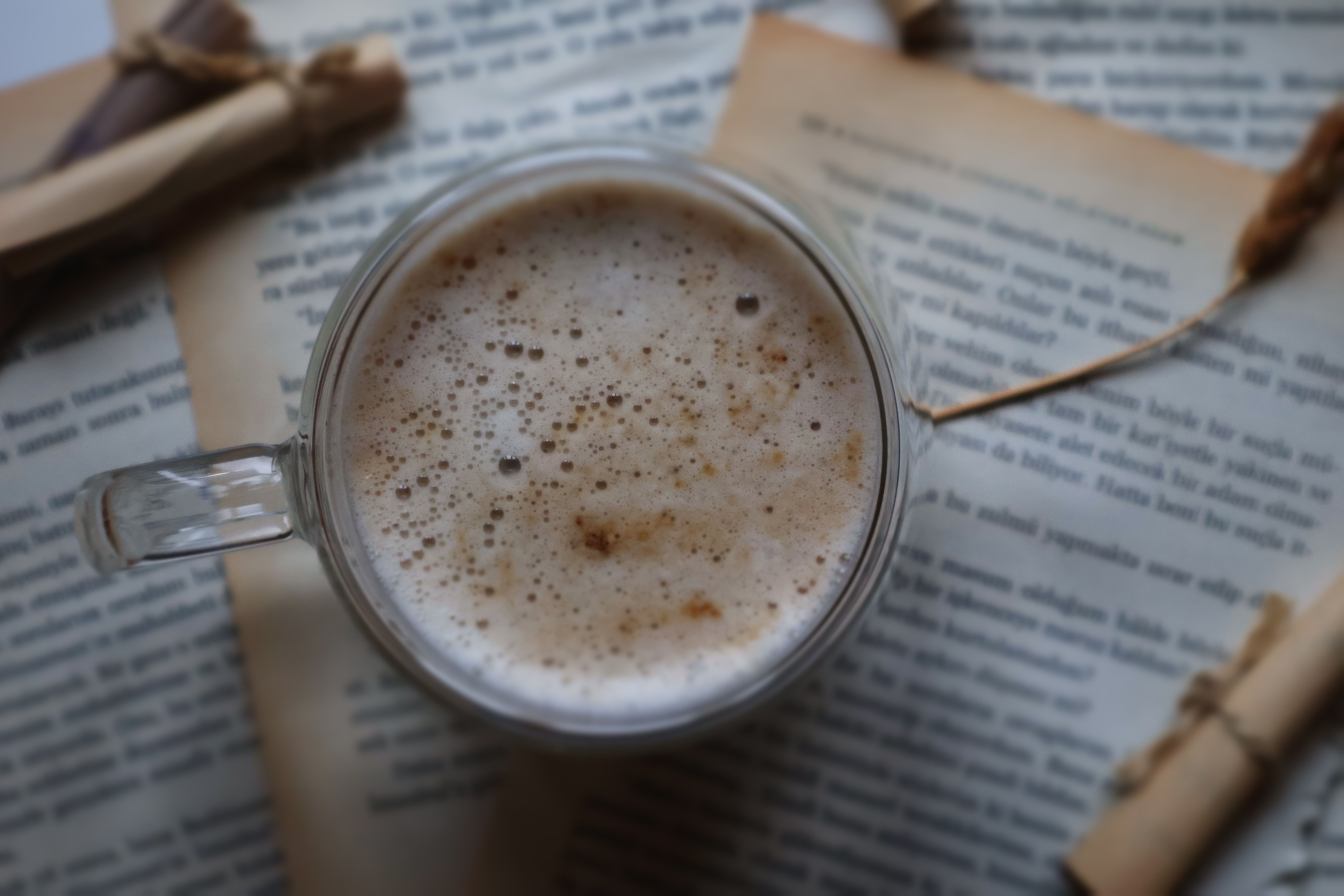 Cozy Coffee Cup with Books and Scrolls · Free Stock Photo