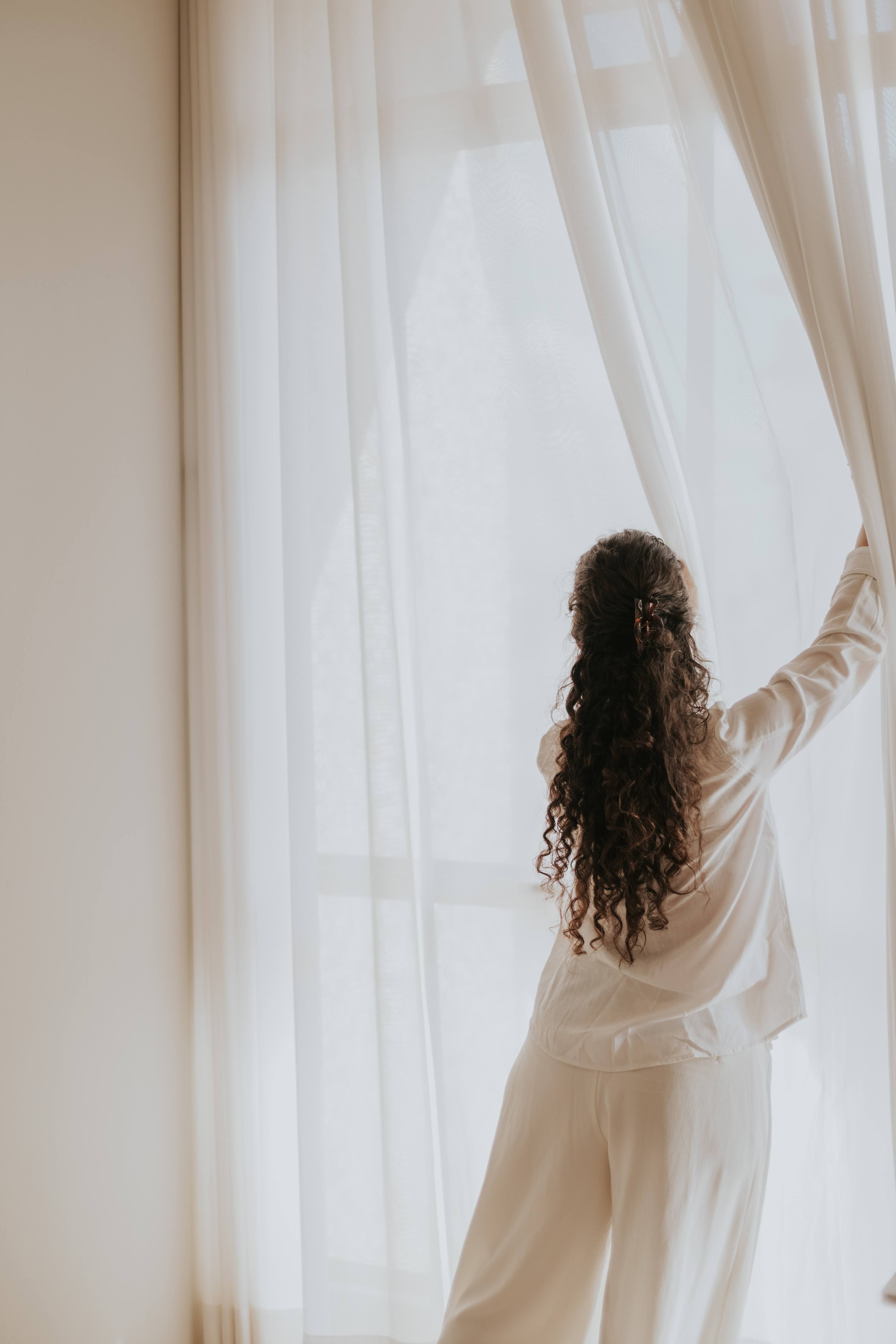 Woman Standing by Window in Light Room · Free Stock Photo