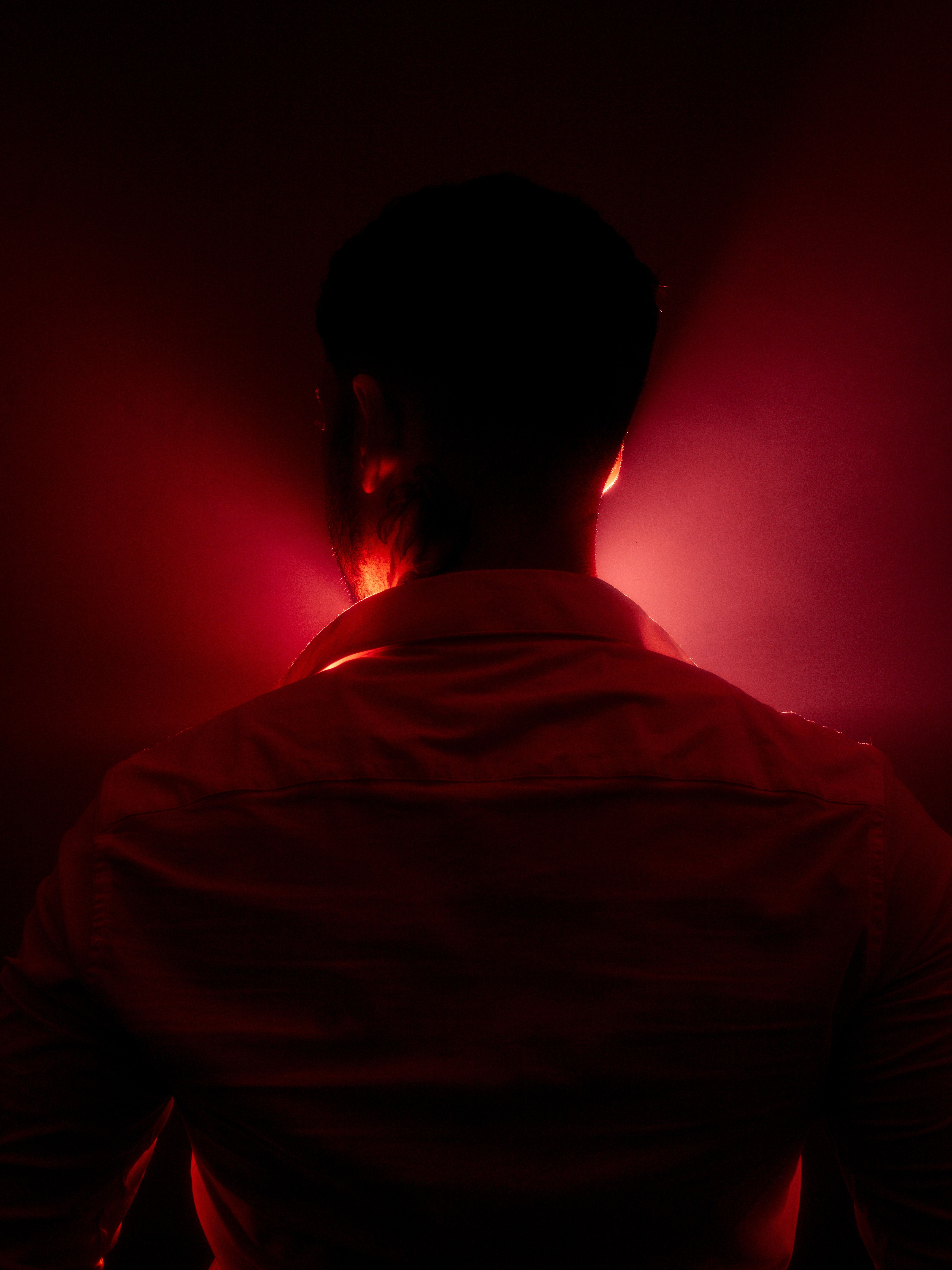 Silhouetted Man Backlit by Dramatic Red Light · Free Stock Photo