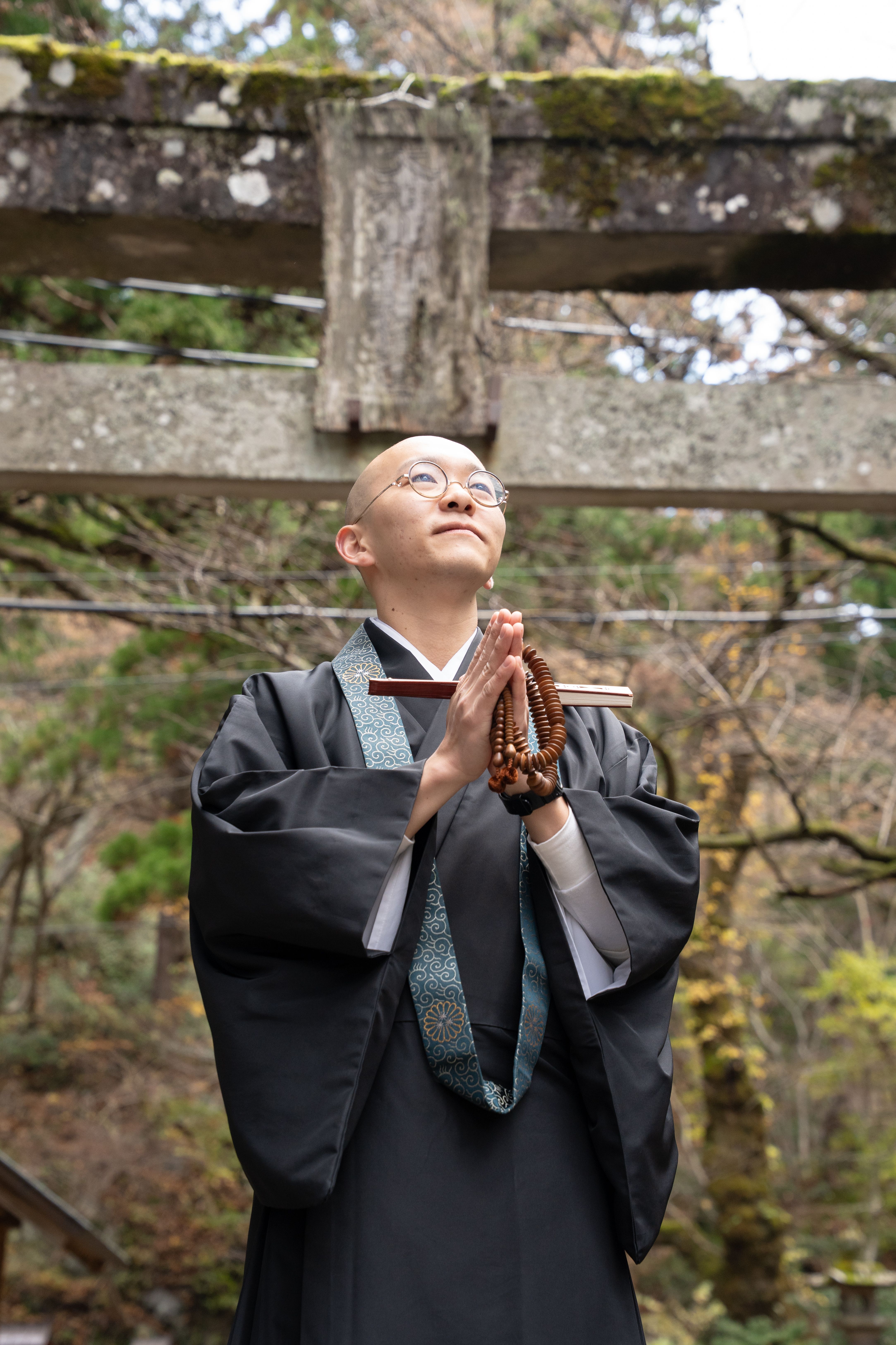 Buddhist Monk Praying at Torii Gate in Japan · Free Stock Photo