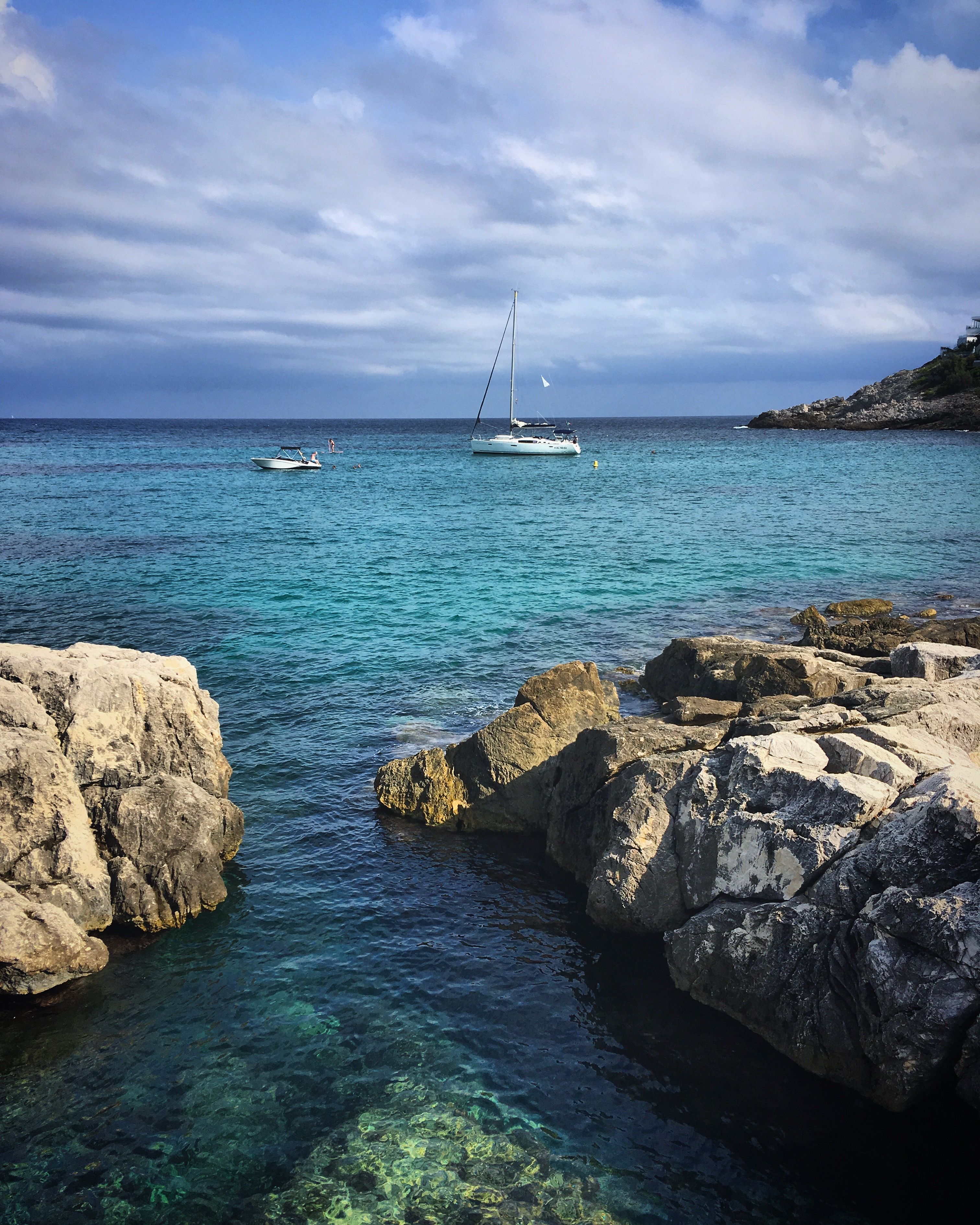 Scenic Mediterranean Cove with Sailboat · Free Stock Photo