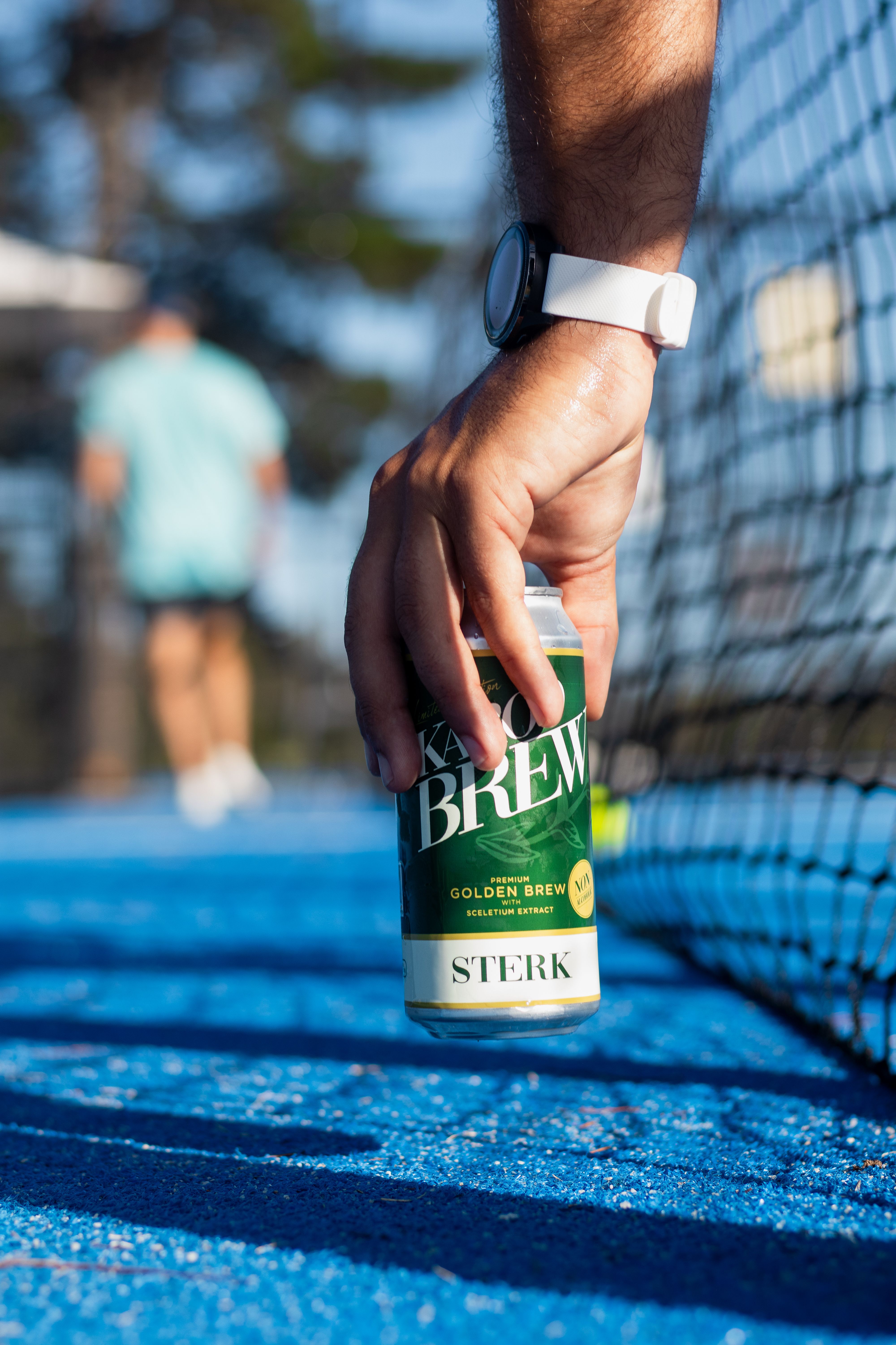 Holding Beer Can on Tennis Court · Free Stock Photo