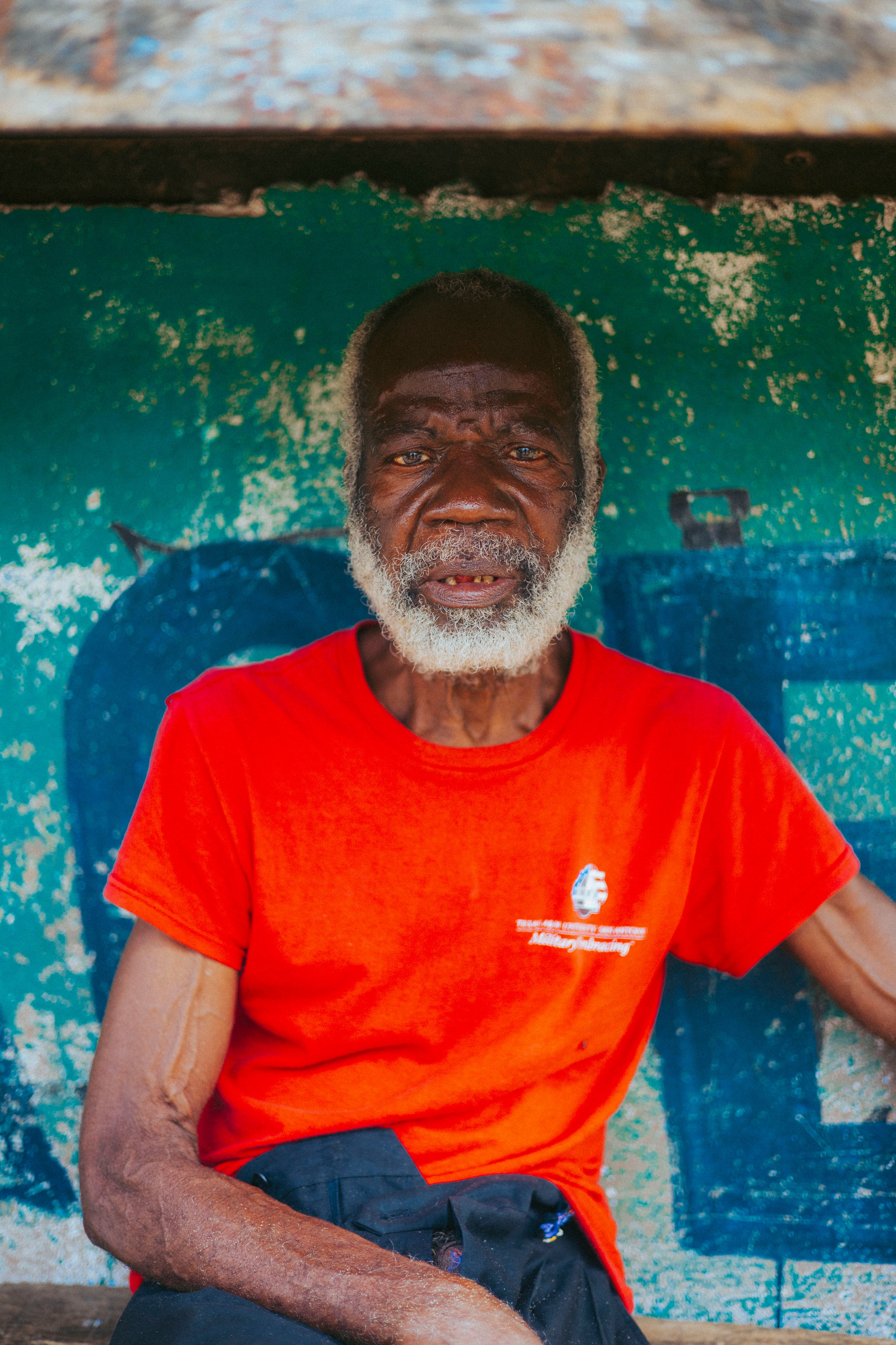 Portrait of Elderly Man in Vibrant Red Shirt · Free Stock Photo