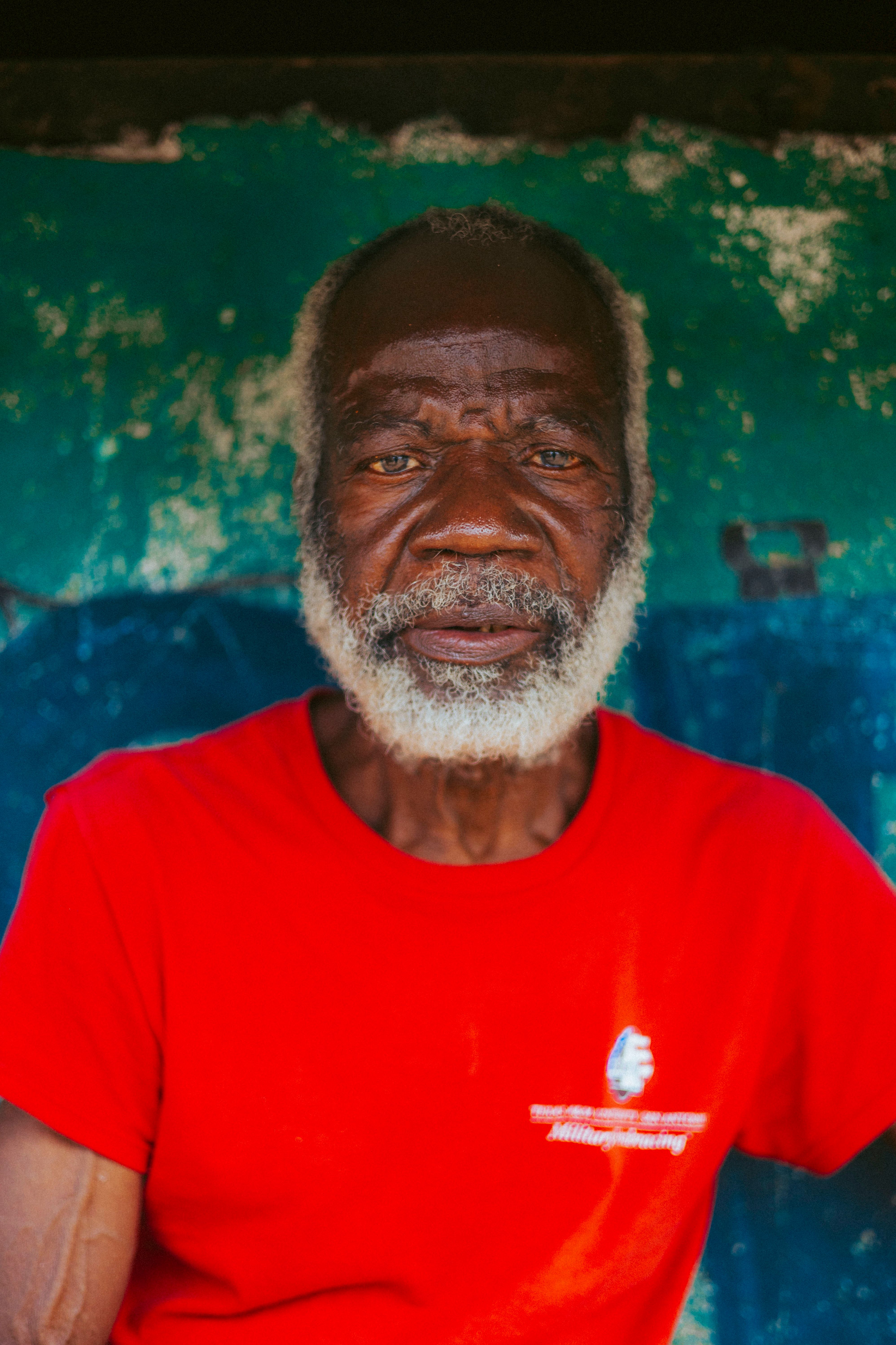 Portrait of Elderly Man in Vibrant Red Shirt · Free Stock Photo
