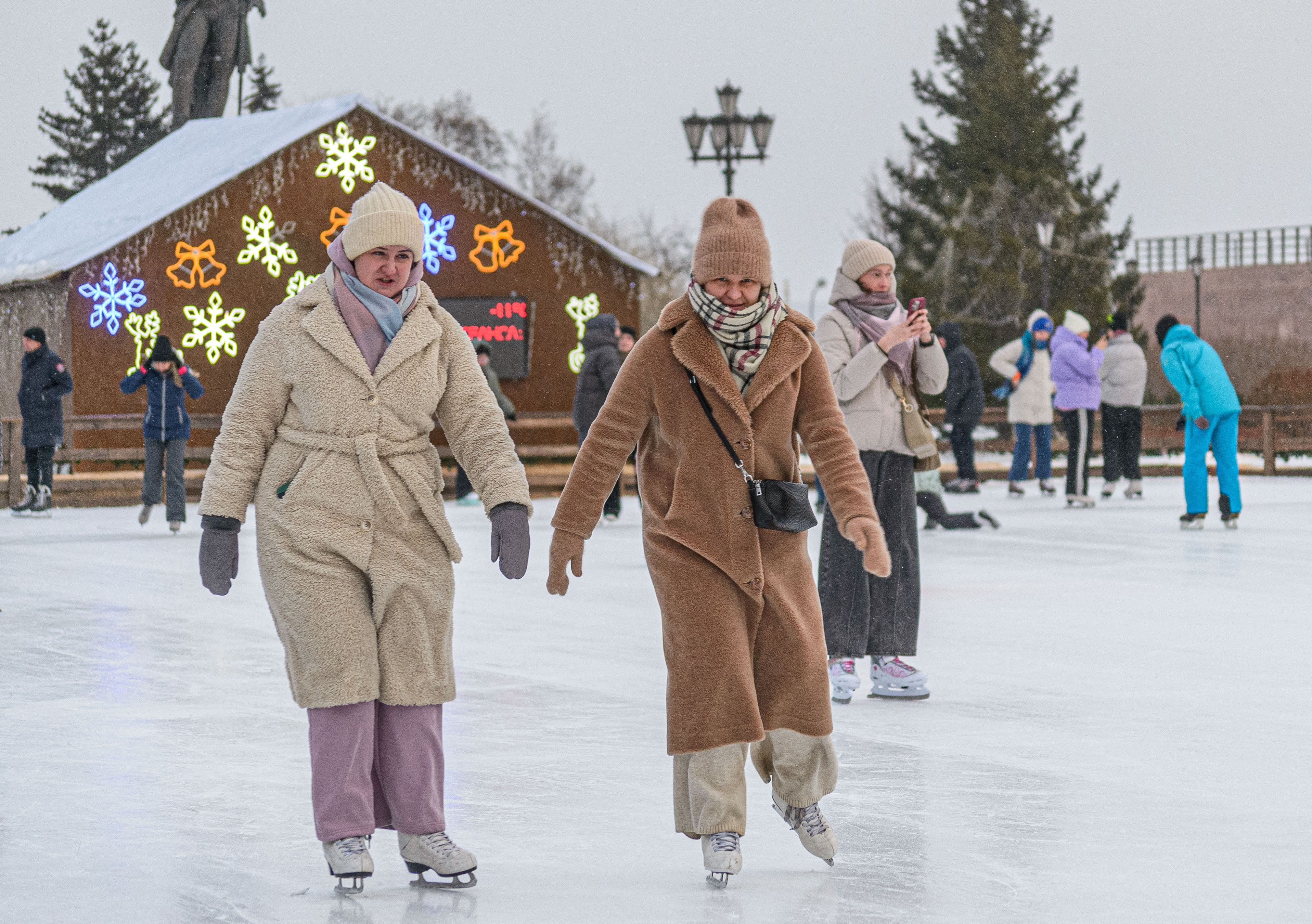 People Ice Skating Outdoors in Winter Setting · Free Stock Photo