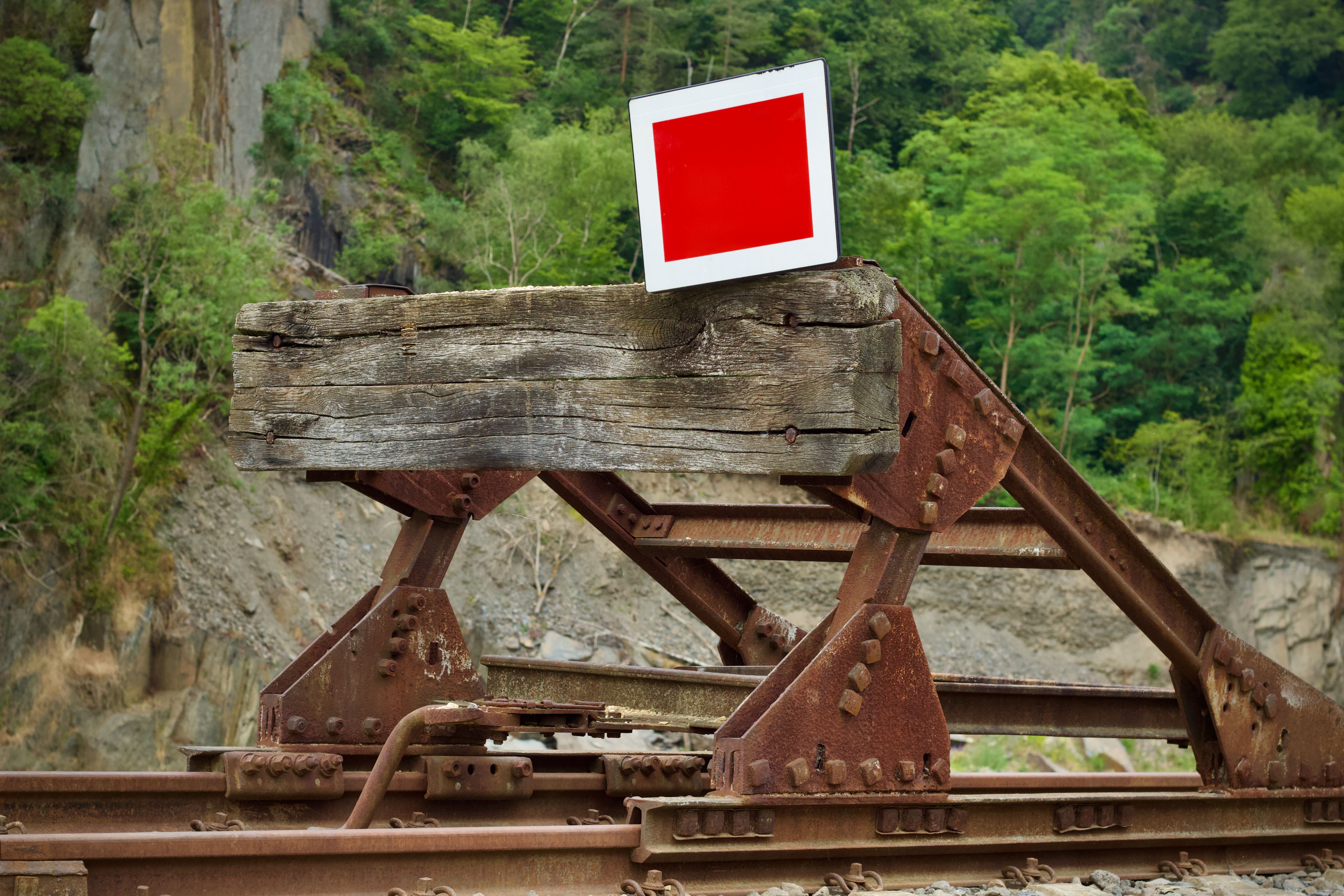 Rustic Railroad Track Barrier in Forest Setting · Free Stock Photo